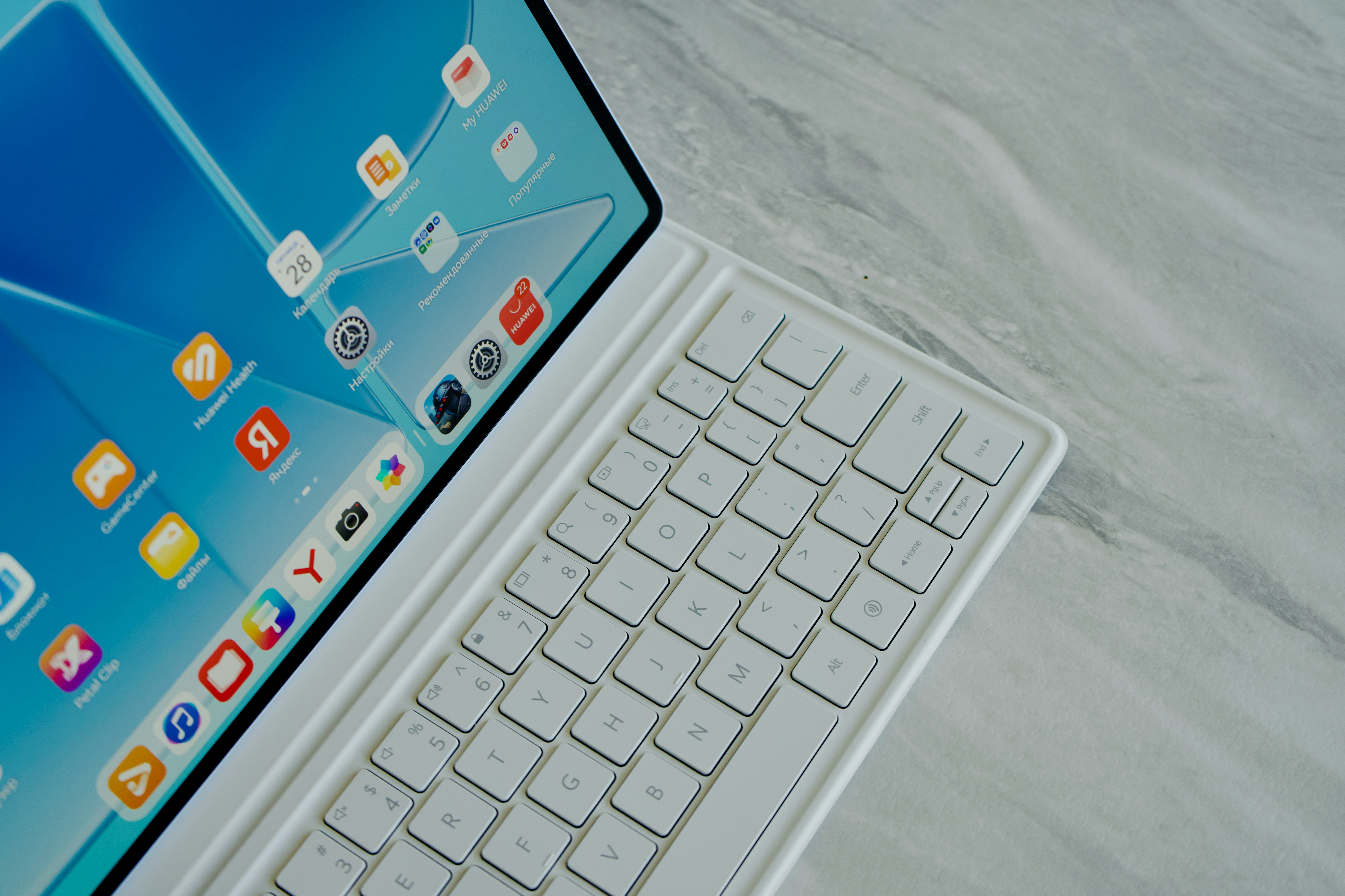 Minimalist Tech Canvas: White Keyboard by a Laptop Bezel