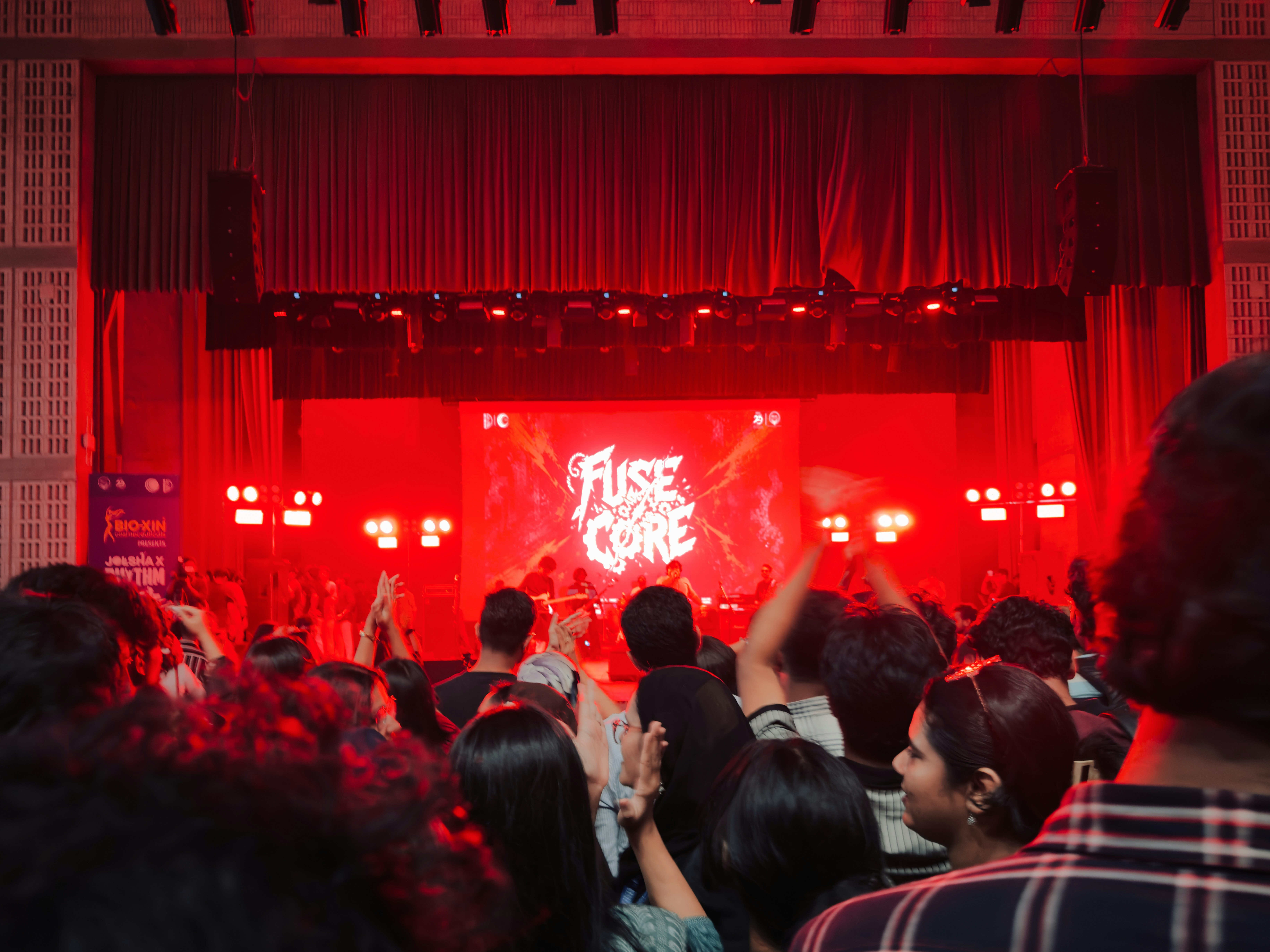 Center Stage: A Red-Hued Arena of Faces and Light
