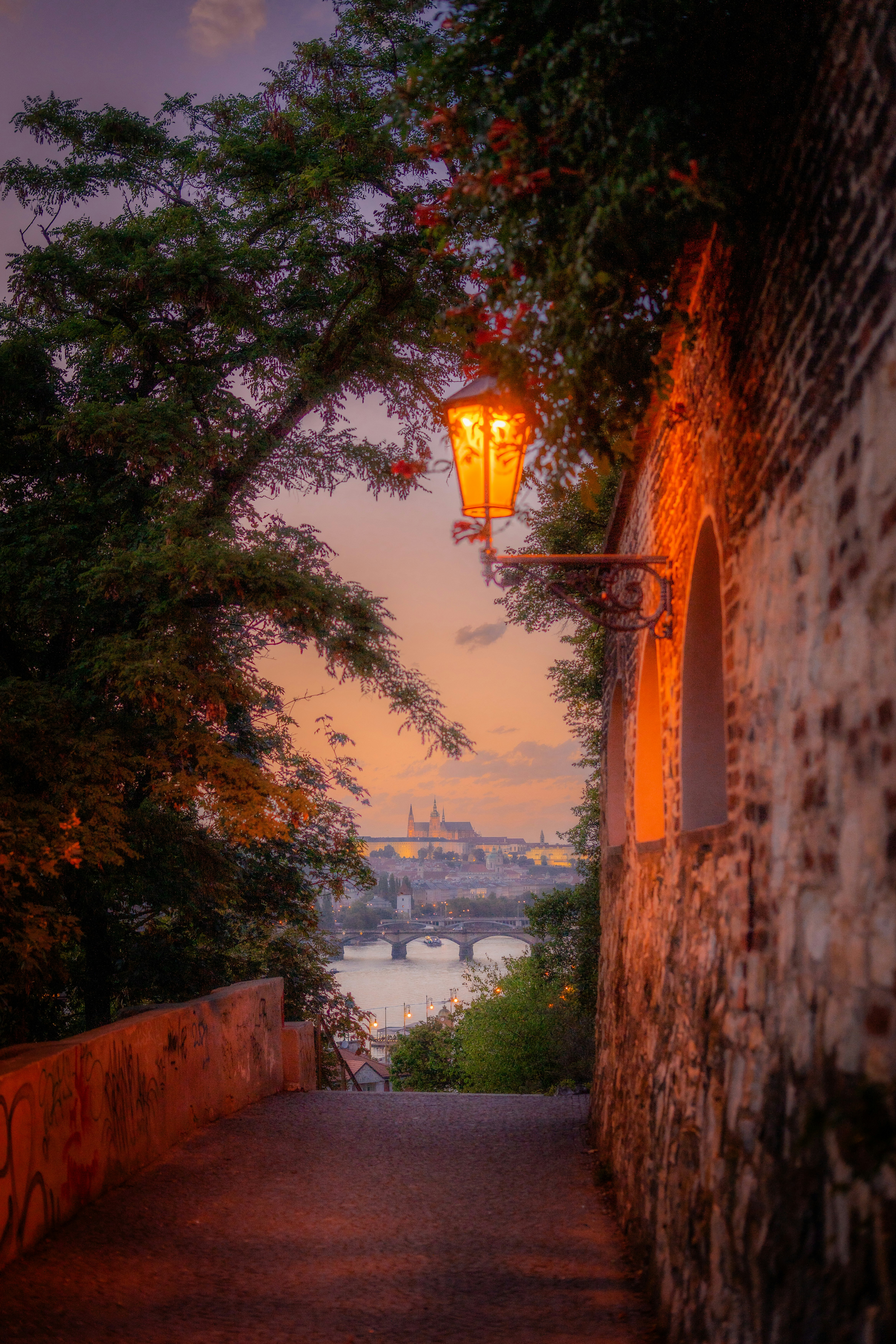 Lantern-lit Alley Overlooking a River City