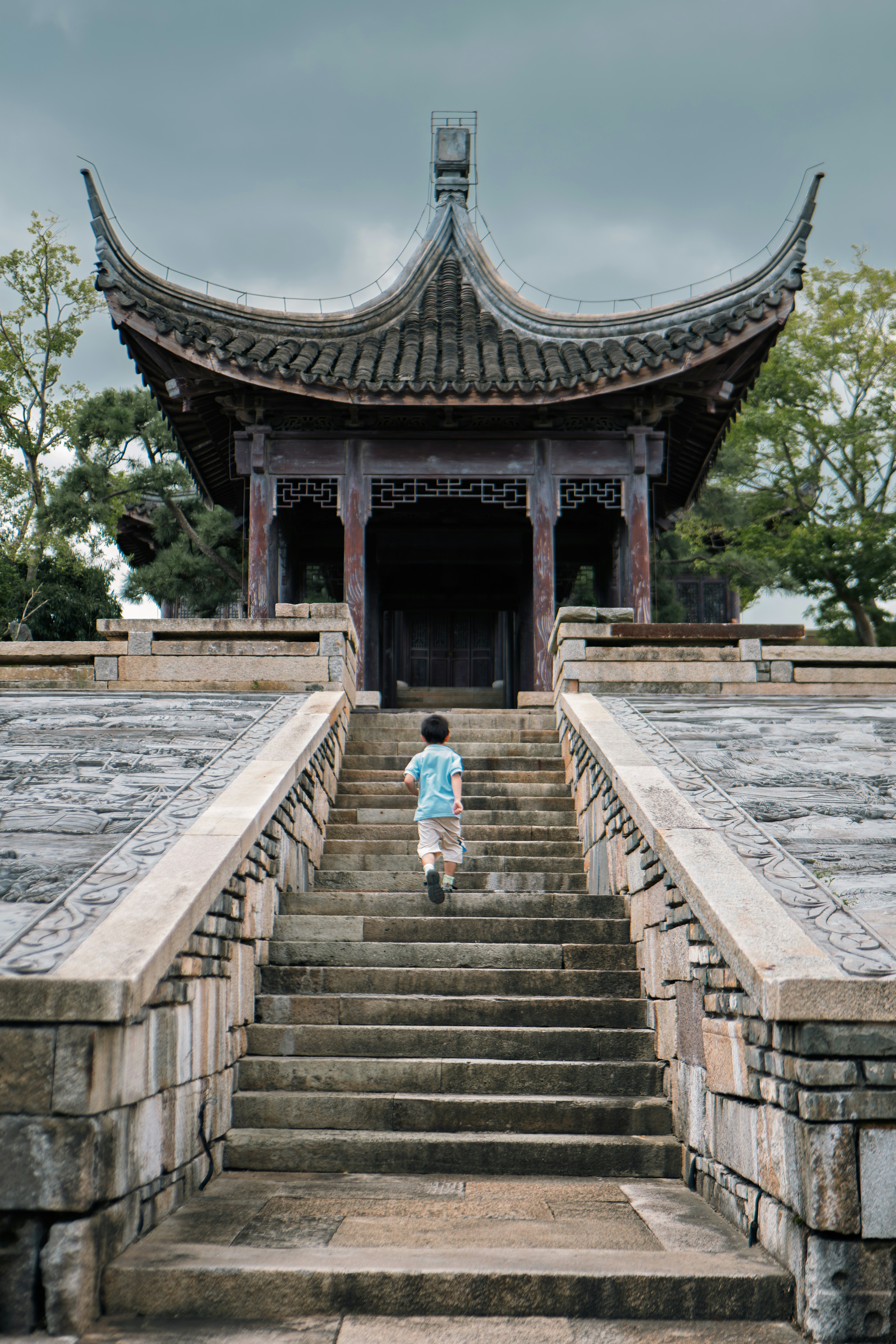 Steps Toward the Temple: A Child Ascends the Ancient Staircase