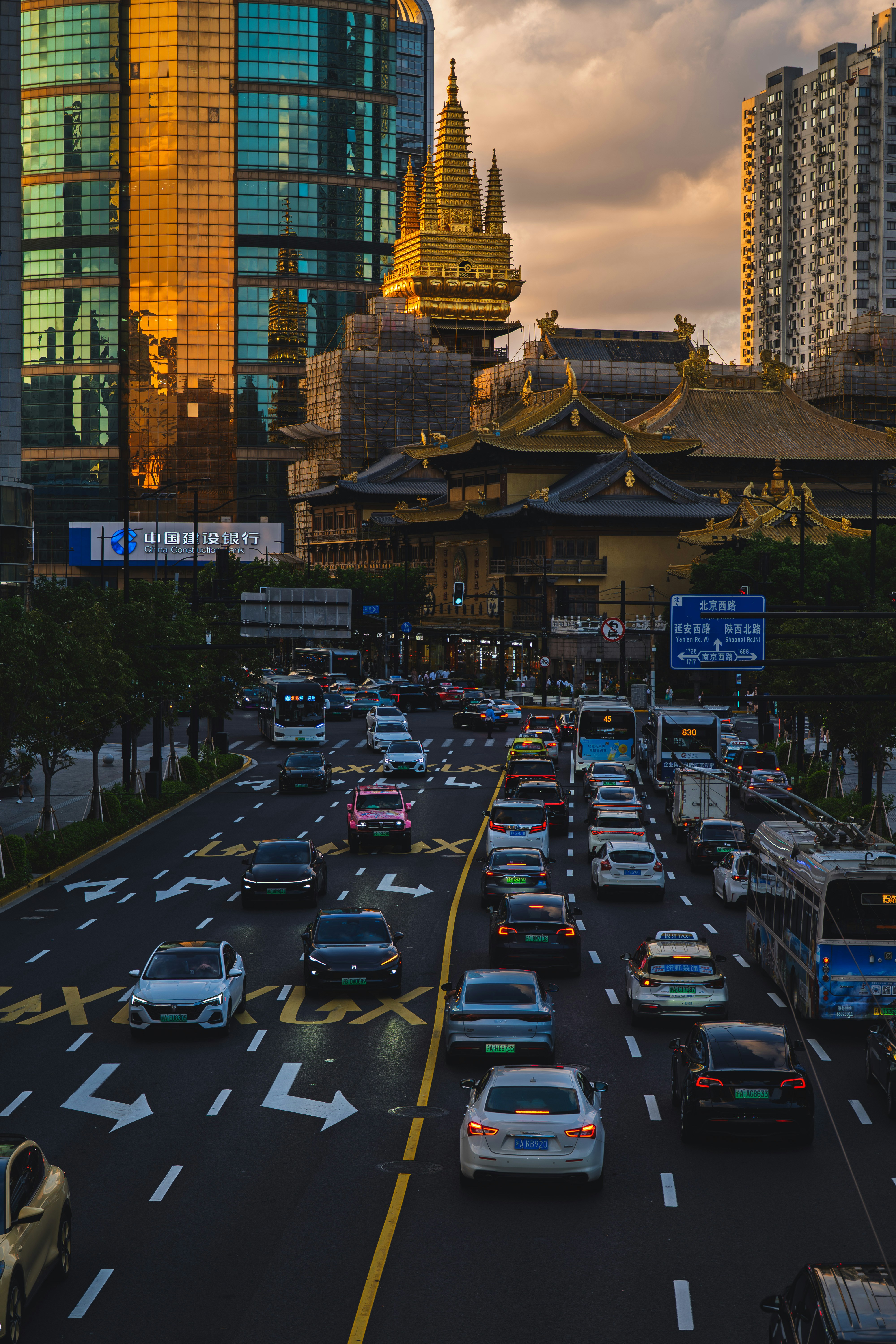 Urban Confluence: A Temple’s Golden Glow Over a River of Traffic