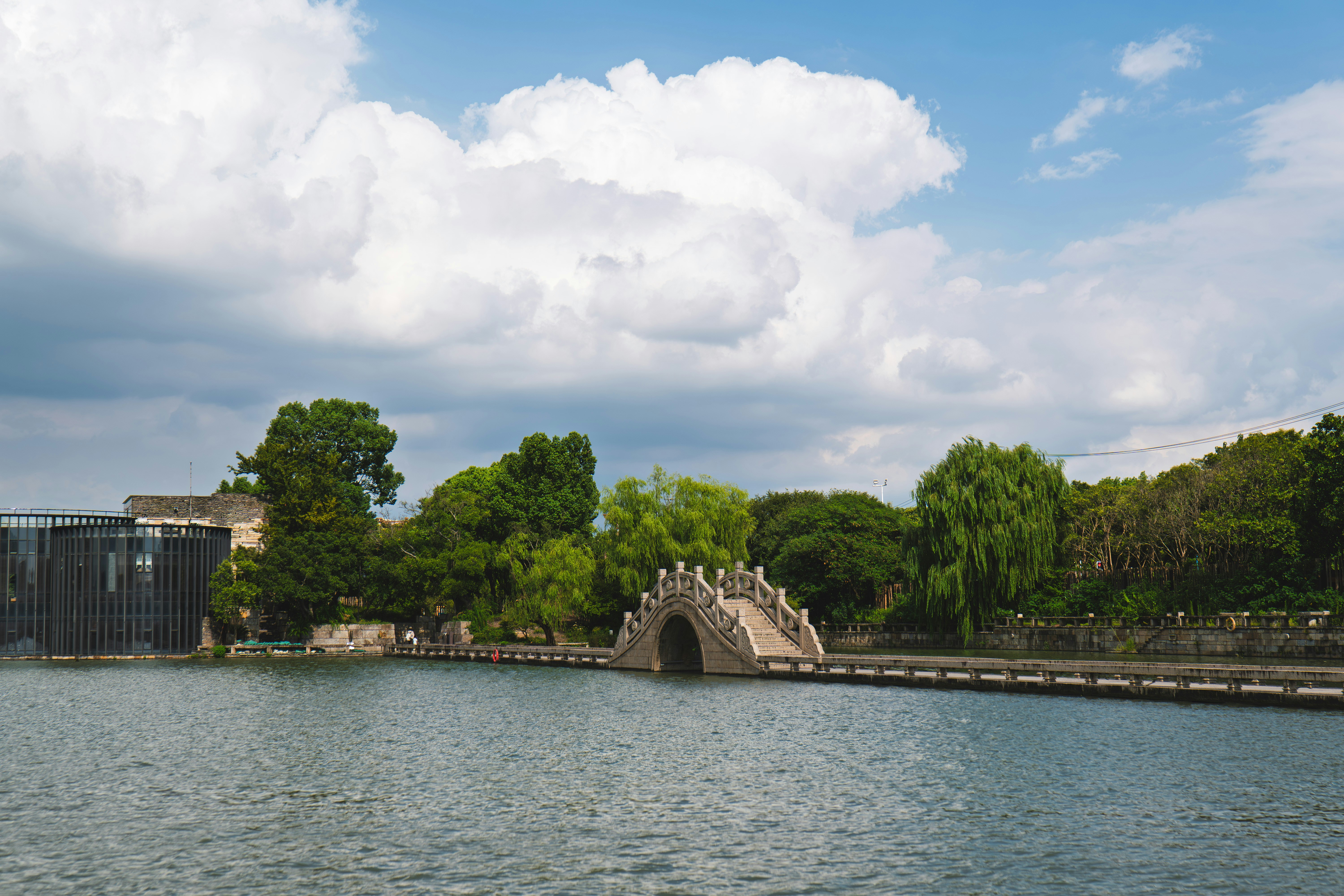 The Stone Bridge Embraced by Willow and Sky