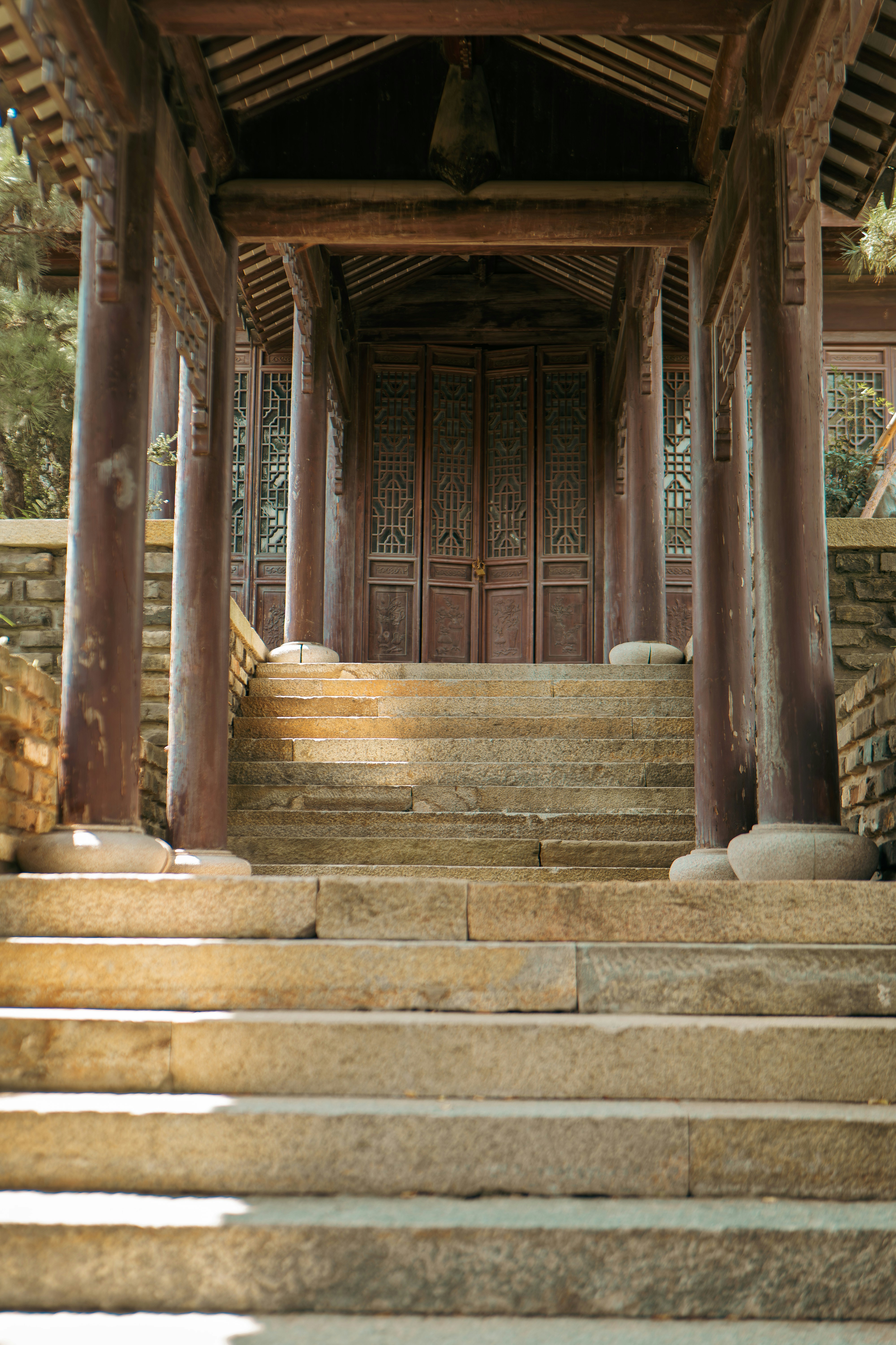 Steps to a Quiet Shrine: Wooden Perimeter and Carved Doors