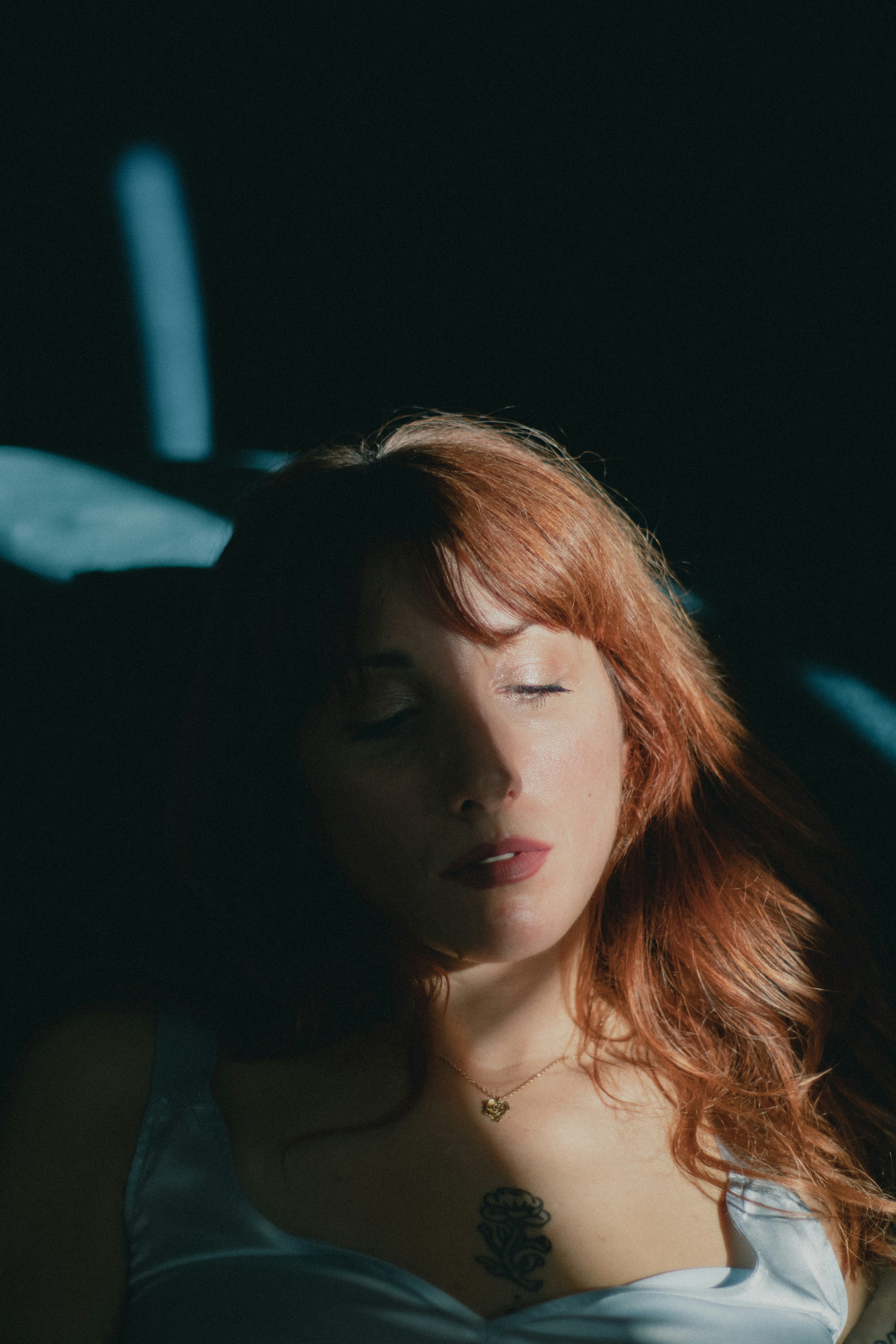 Sunlit Red Hair in Quiet Darkness