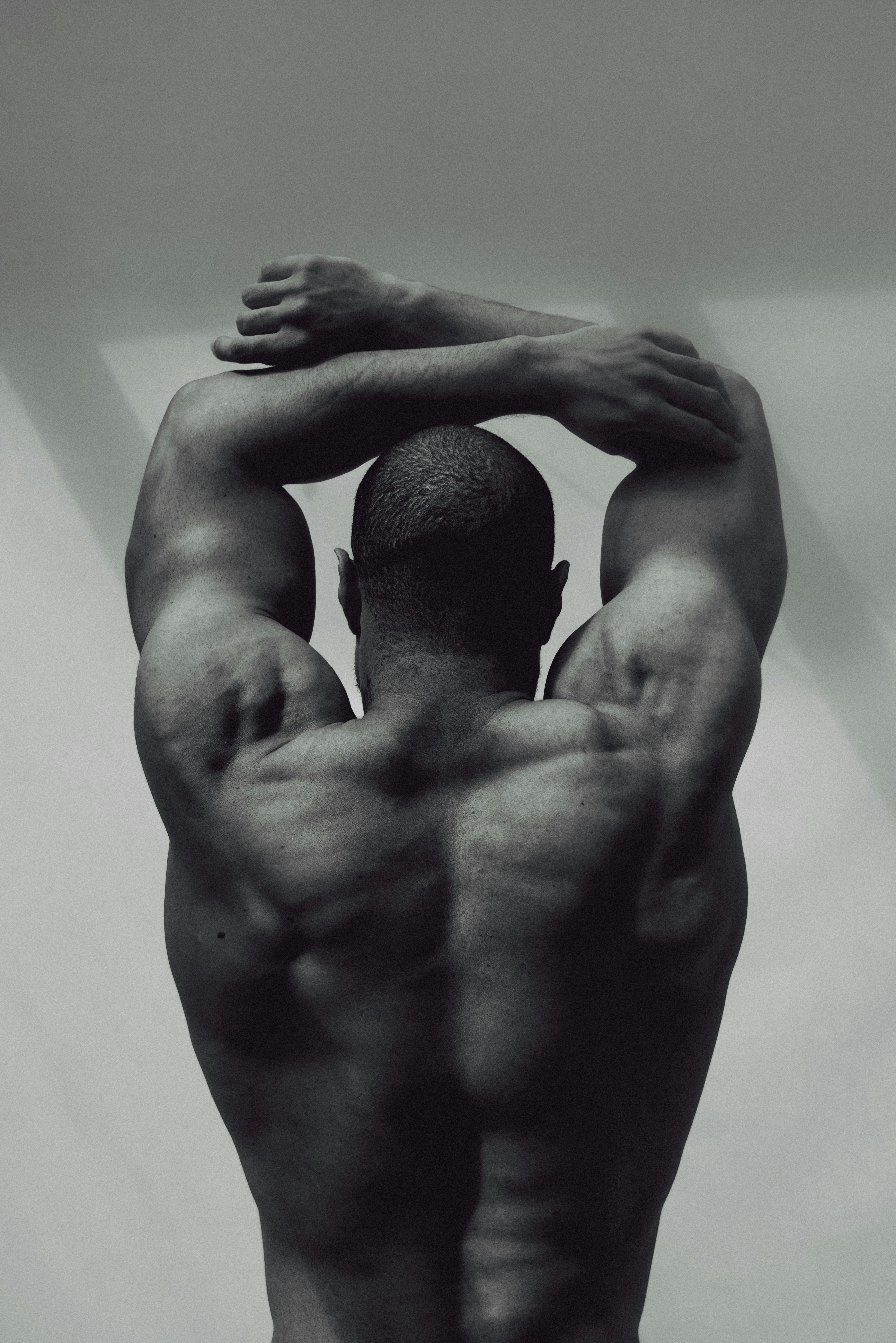 Backlit Strength: The Muscular Silhouette in Mono