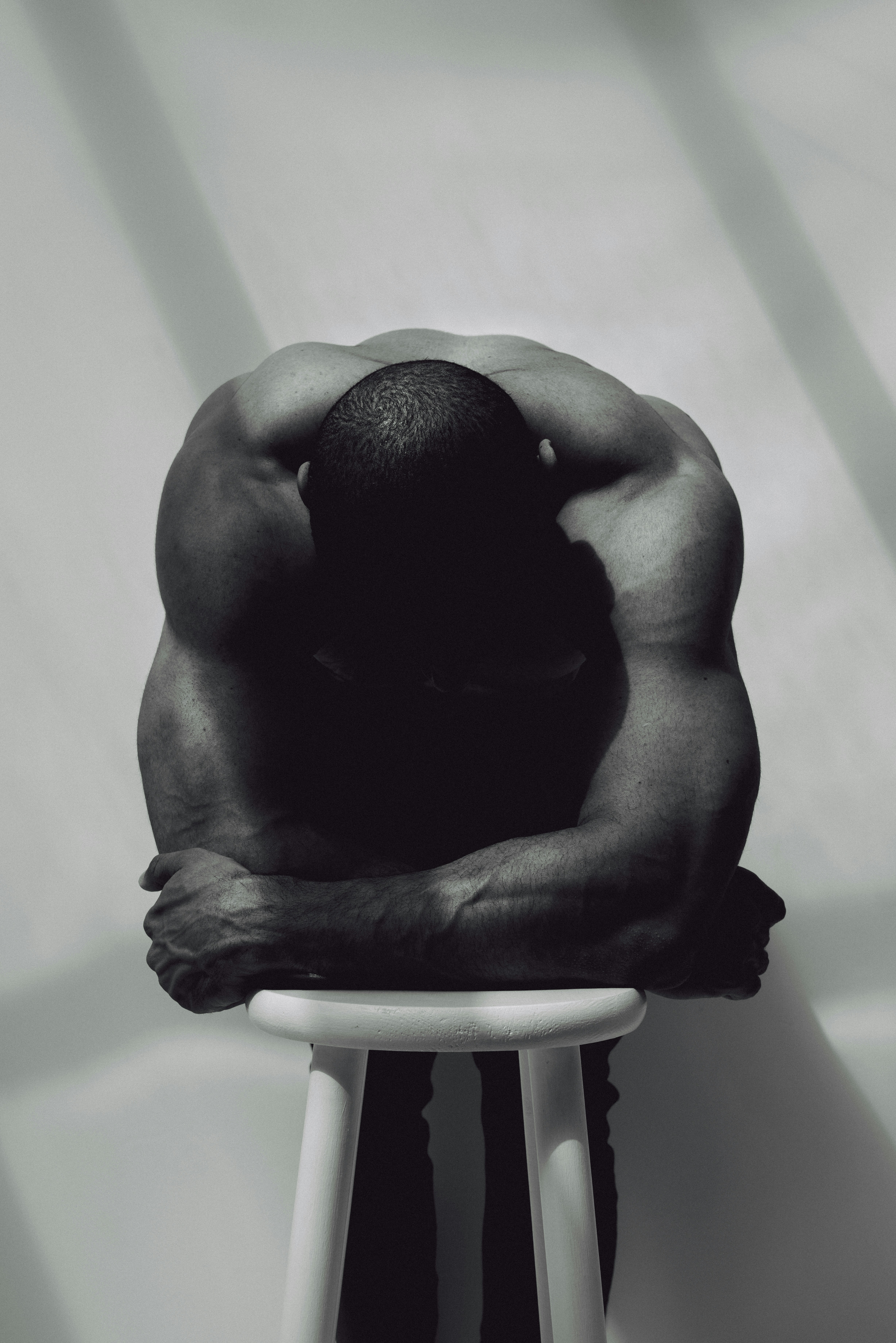 Silence on the Stool: A Study in Shadow and Form