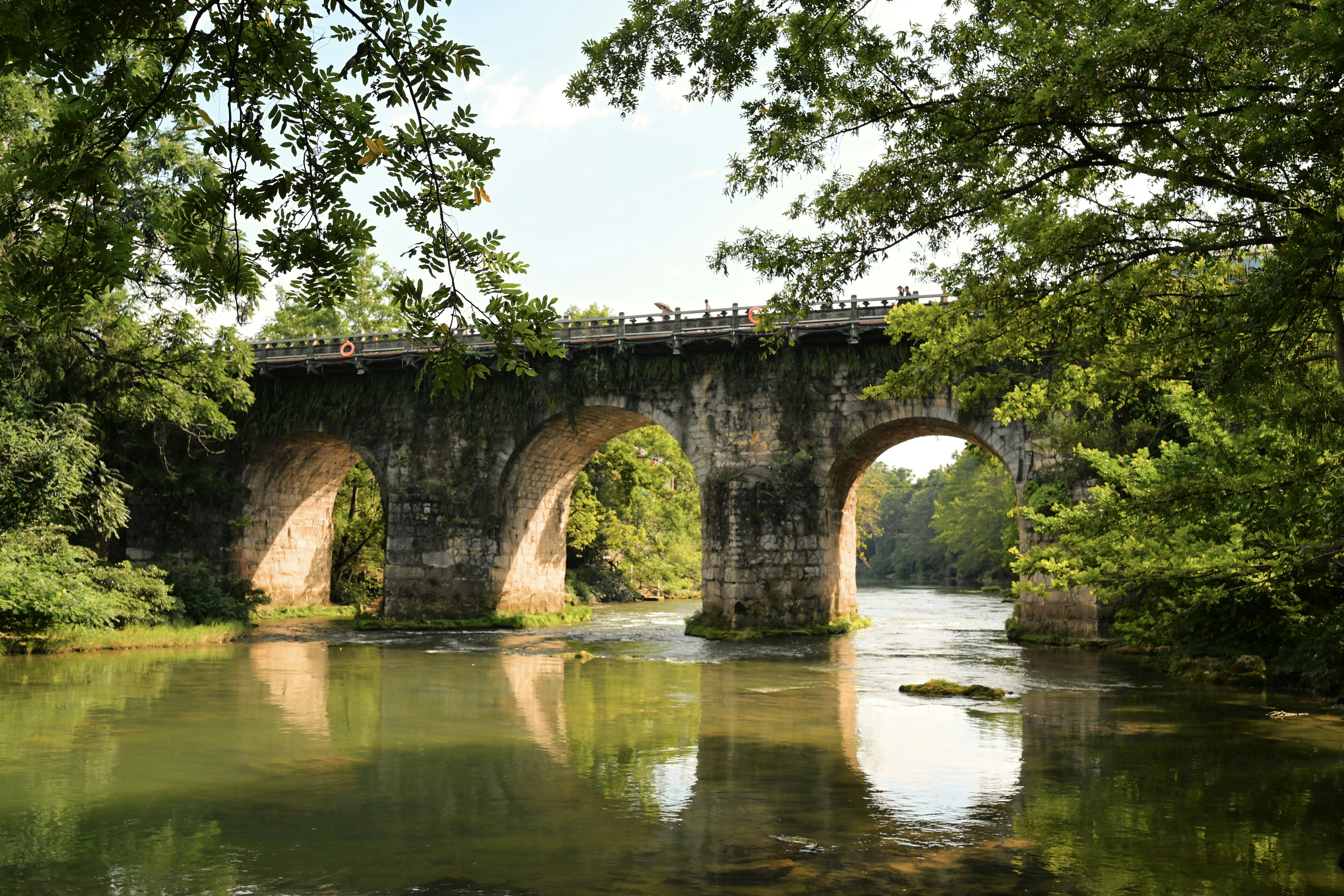 Whispering Arches: A Quiet Crossing Over Green Waters