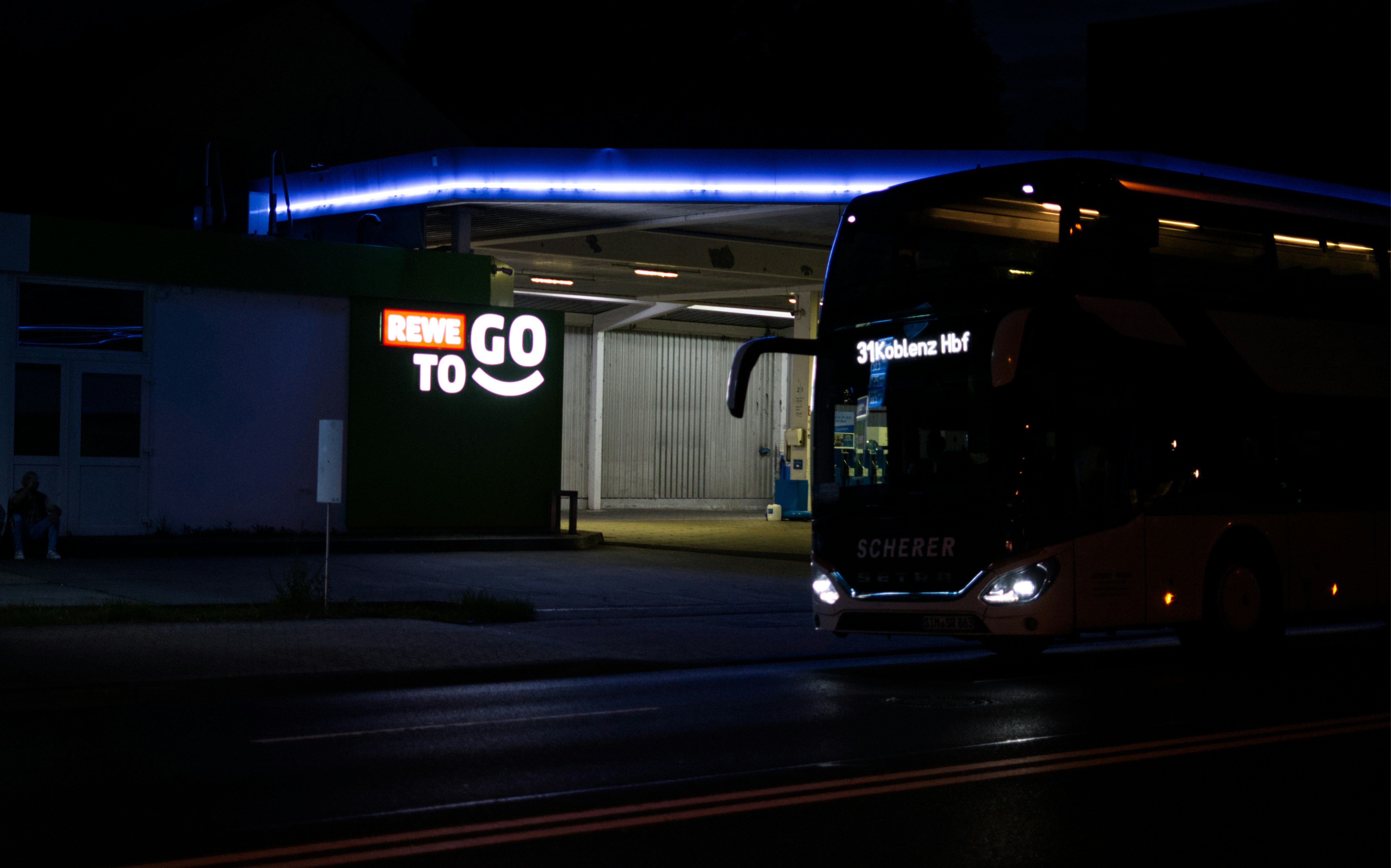 Night Bus Stop: Neon Glow By the Station
