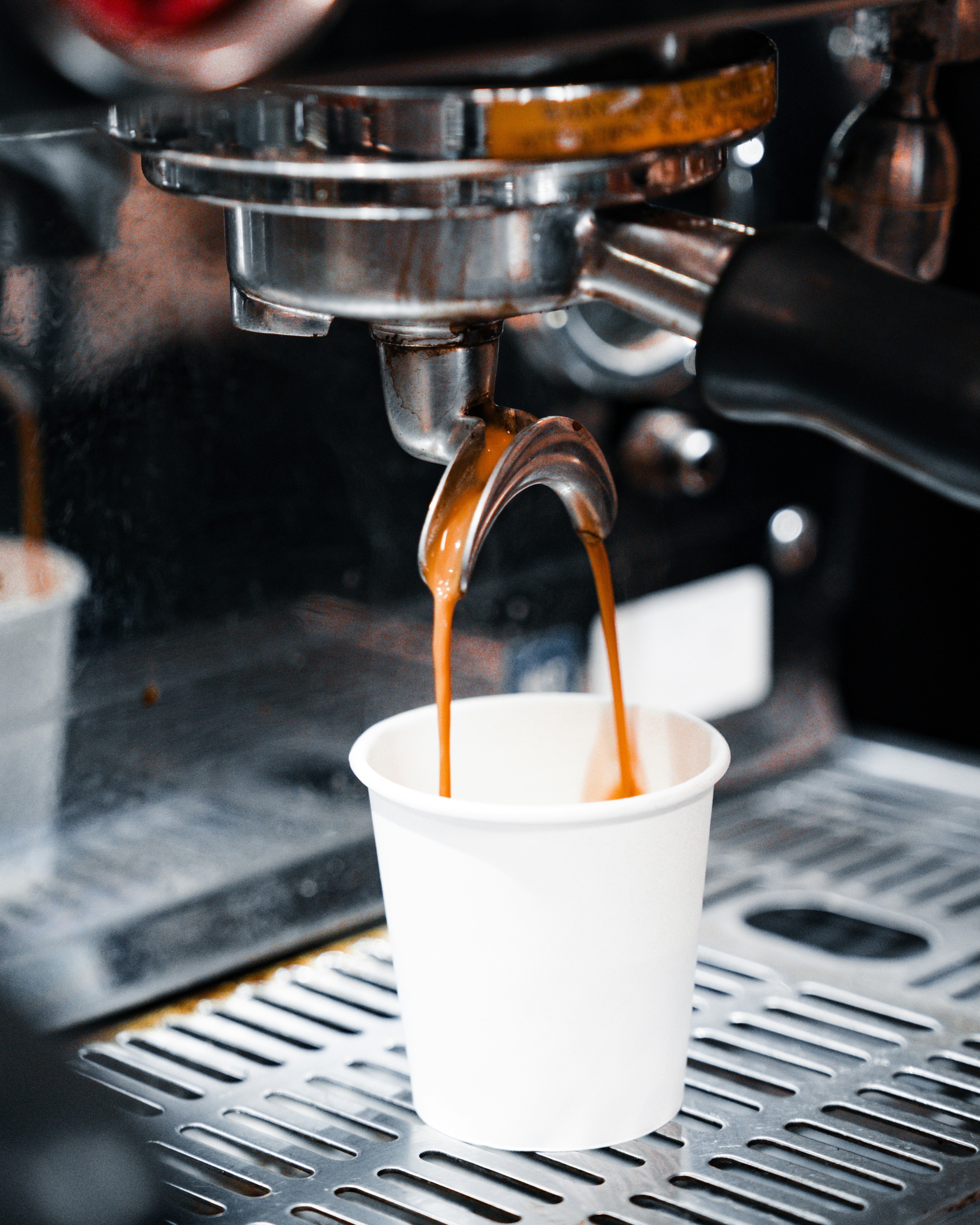 Espresso Stream: Dark Elixir Drops into a White Cup