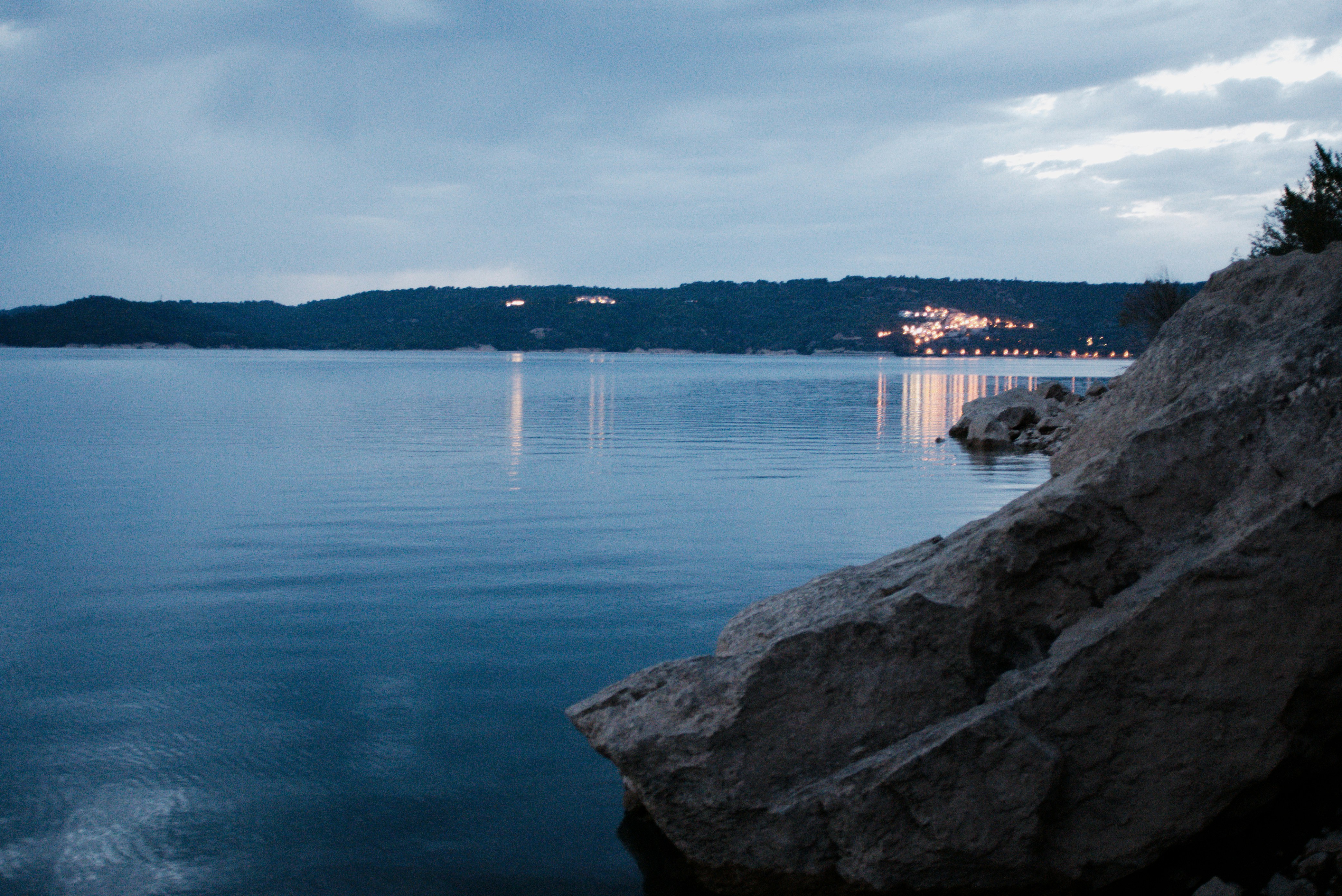 Moonlit Shoreline: Calm Water and Craggy Foreground