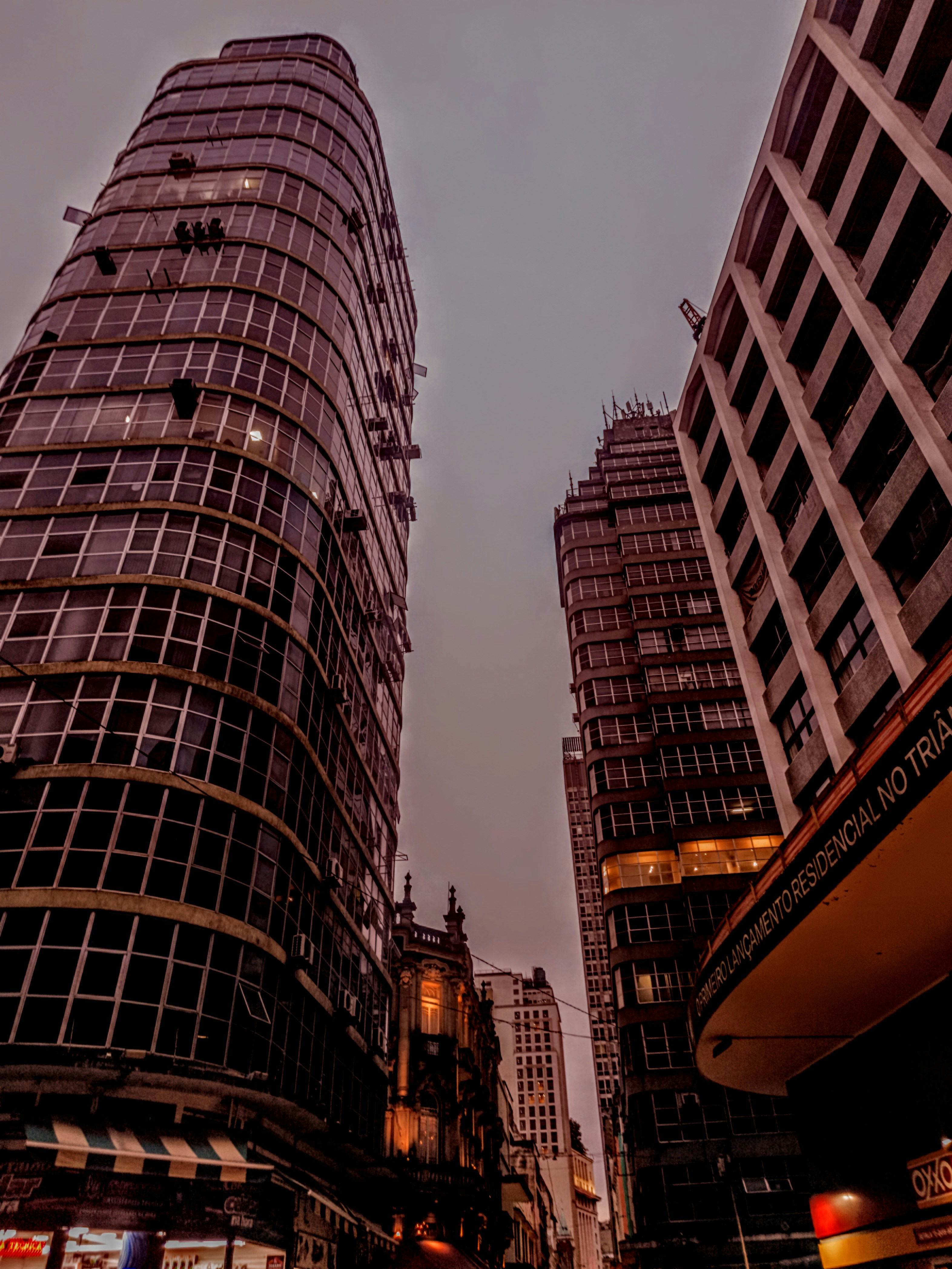 Urban Giants After Sunset: Twin Towers Loom Over a Narrow Street