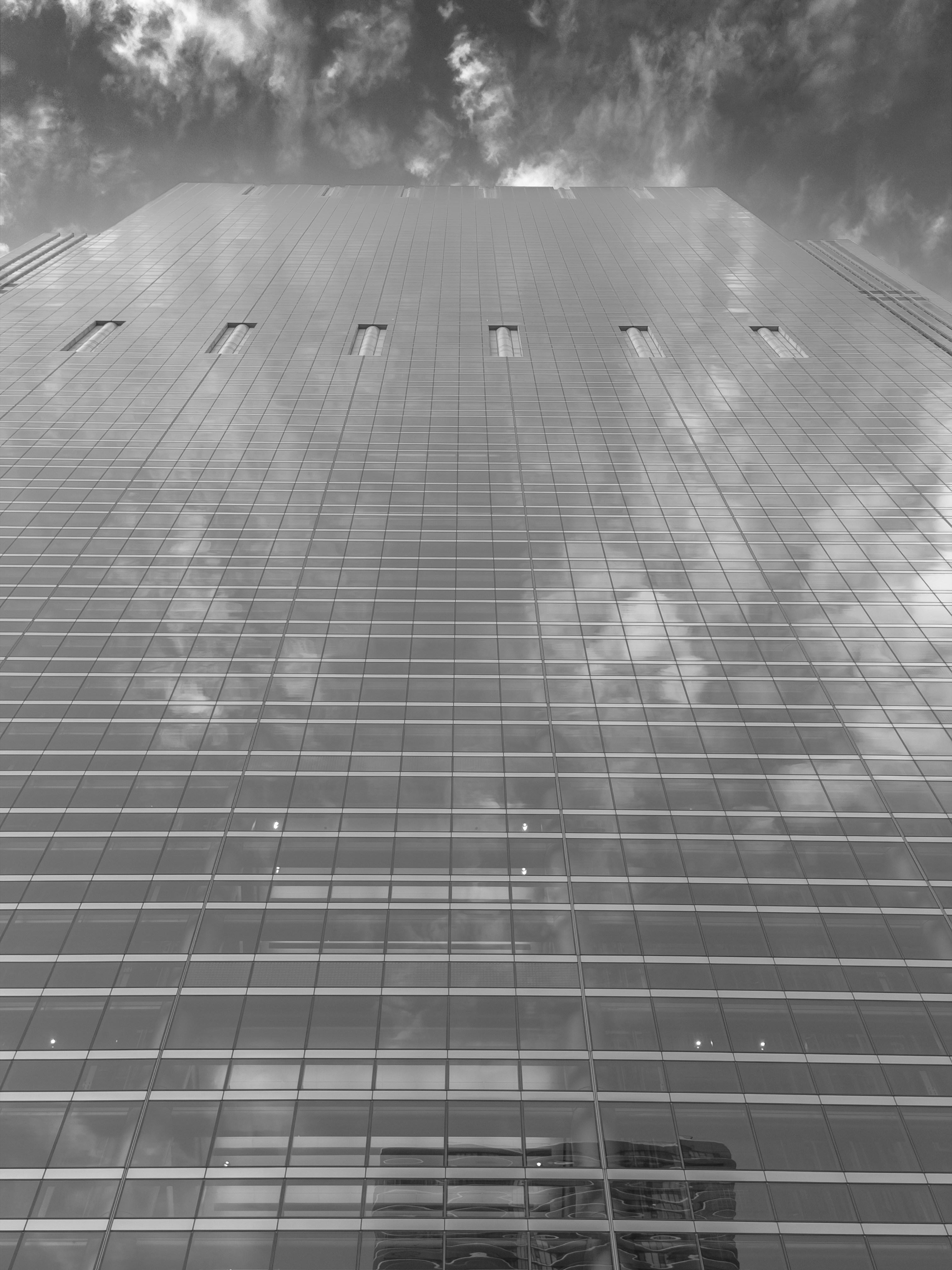 Skyward Glass: A Towering Facade Reflects the Sky