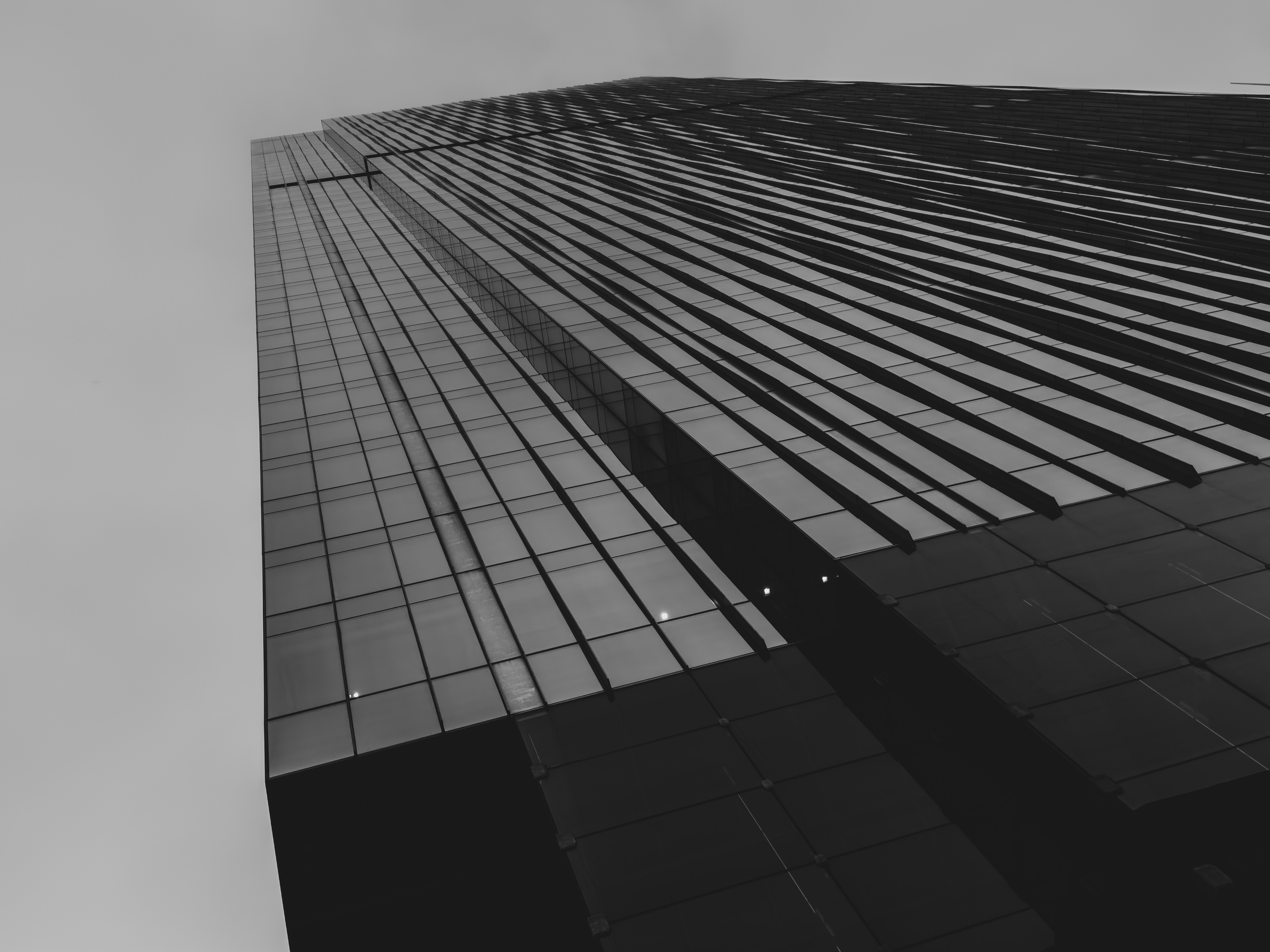 Tilted Glass: A Monochrome Ascent Up the Facade