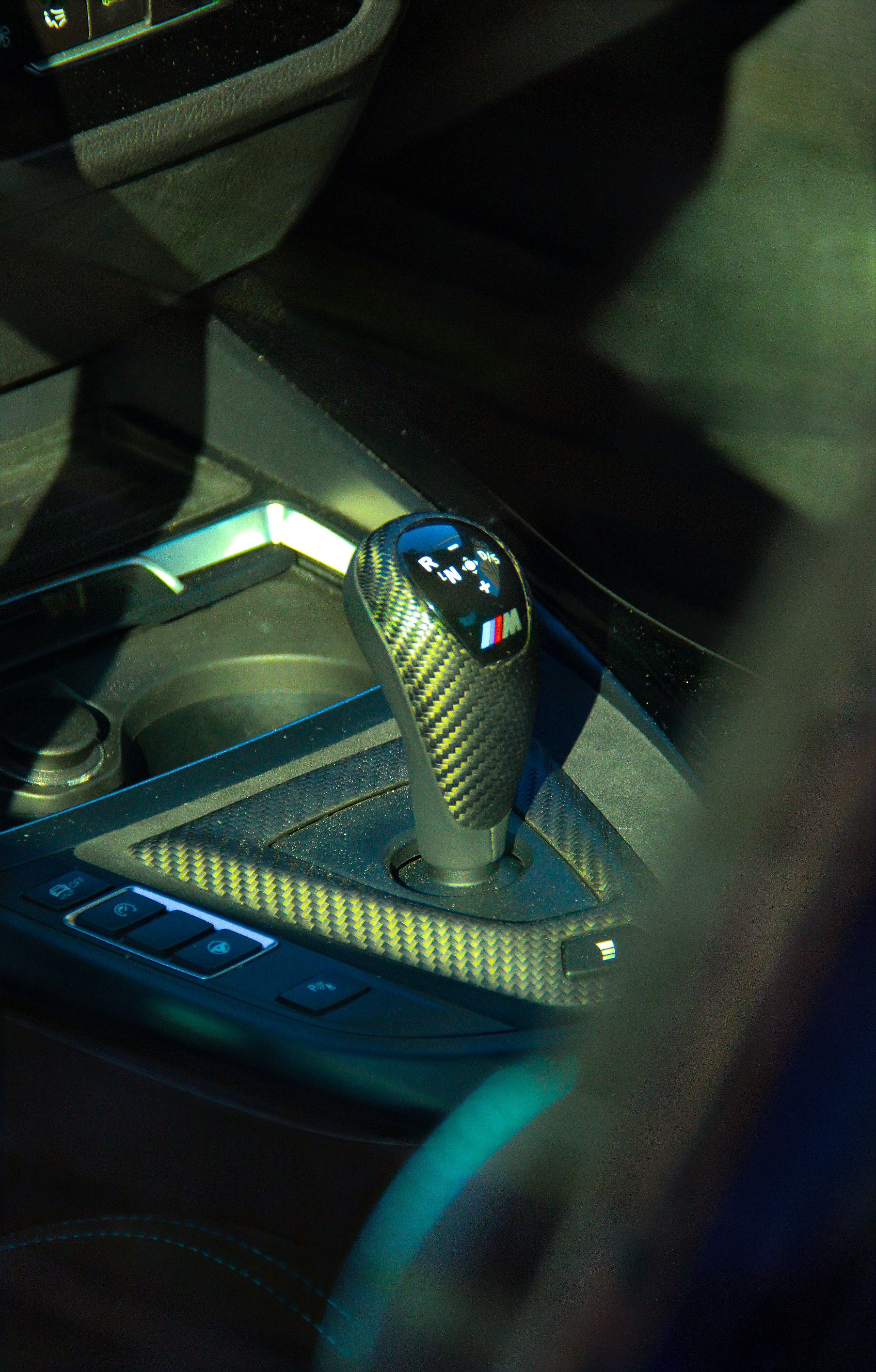 Carbon-fiber shift: the six-speed knob glowing in a quiet car cabin