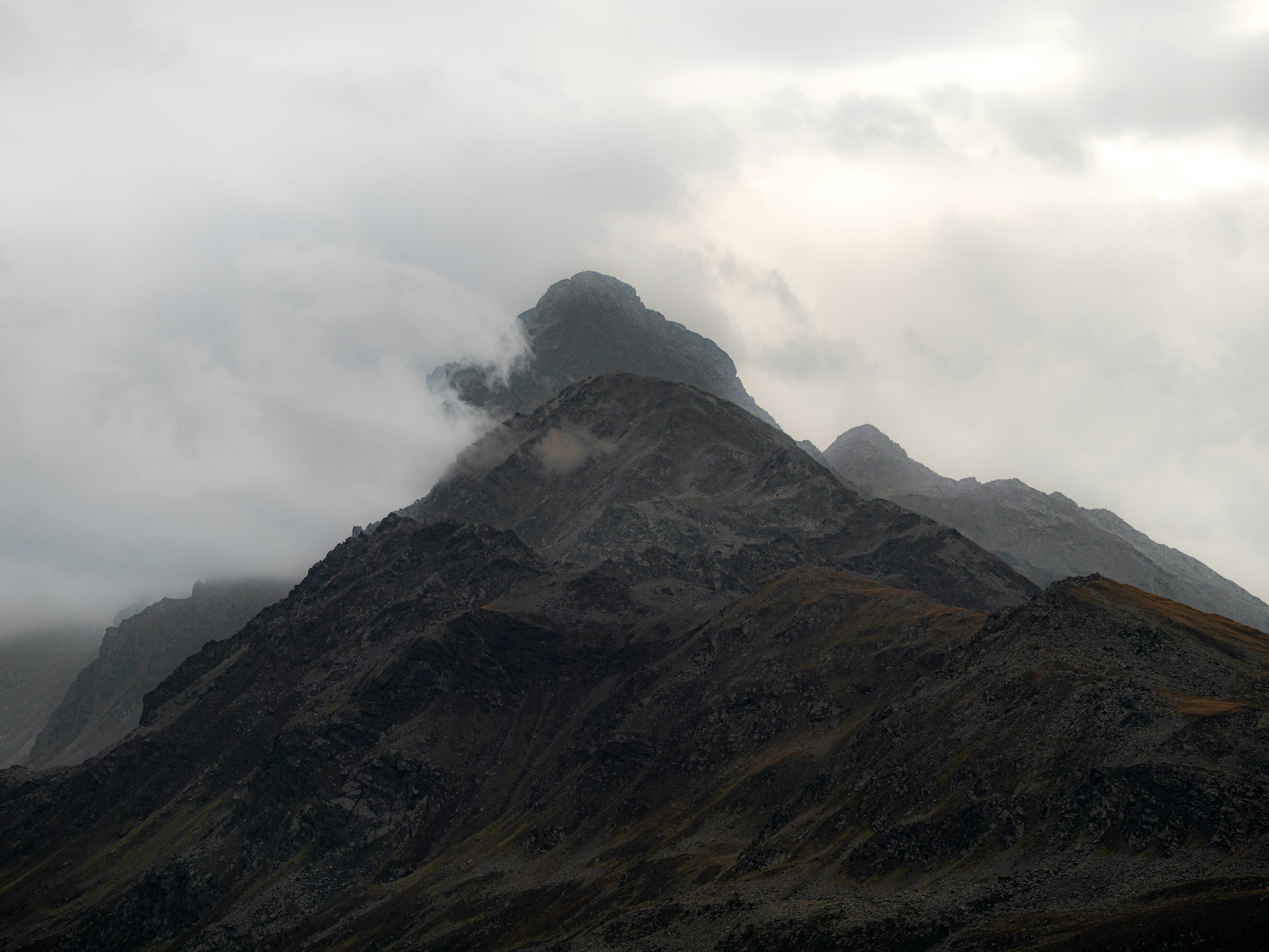 Mist-Clad Summit silhouette over rugged ridge