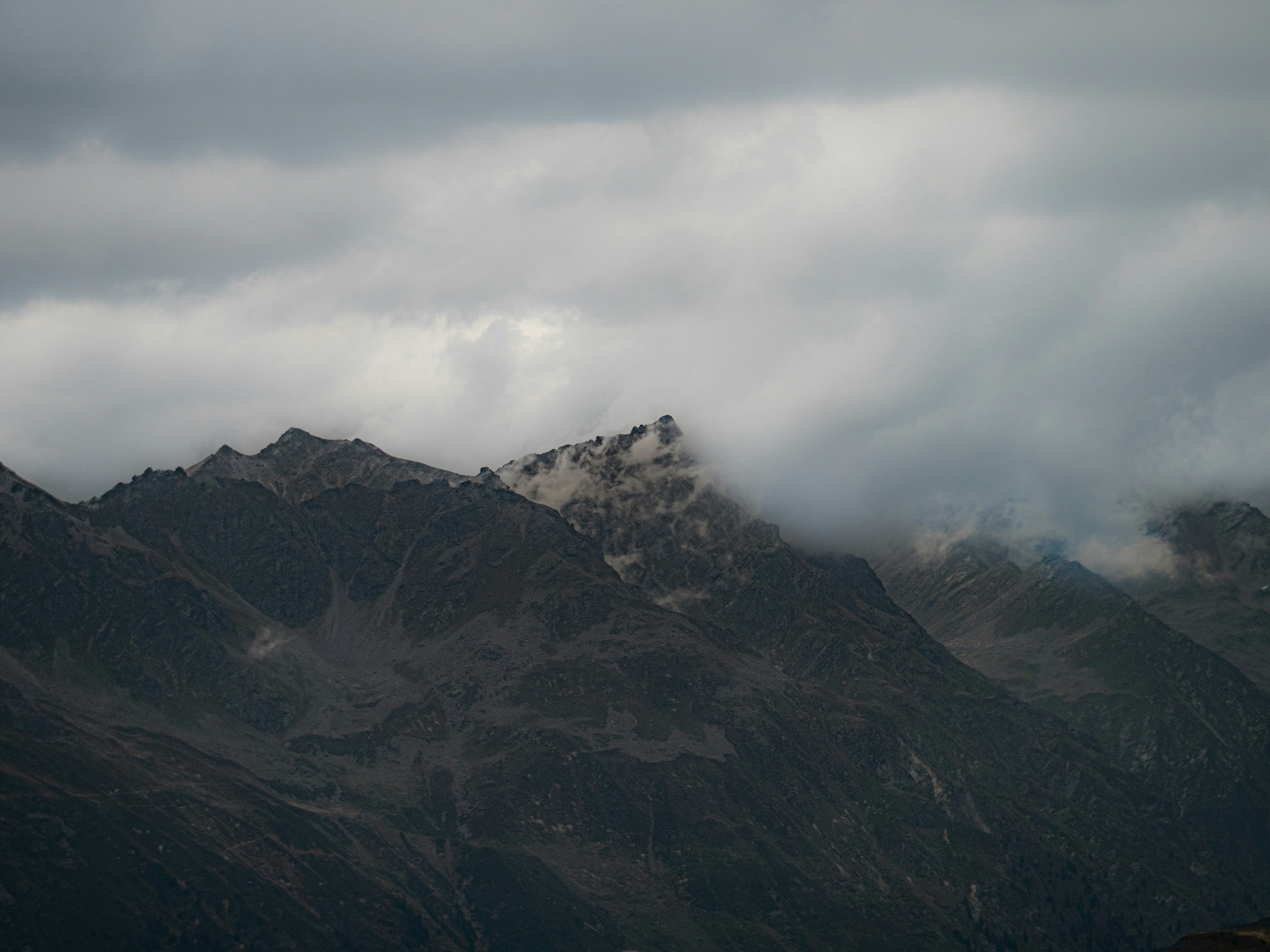 Mist-Clad Peak Under a Brooding Sky