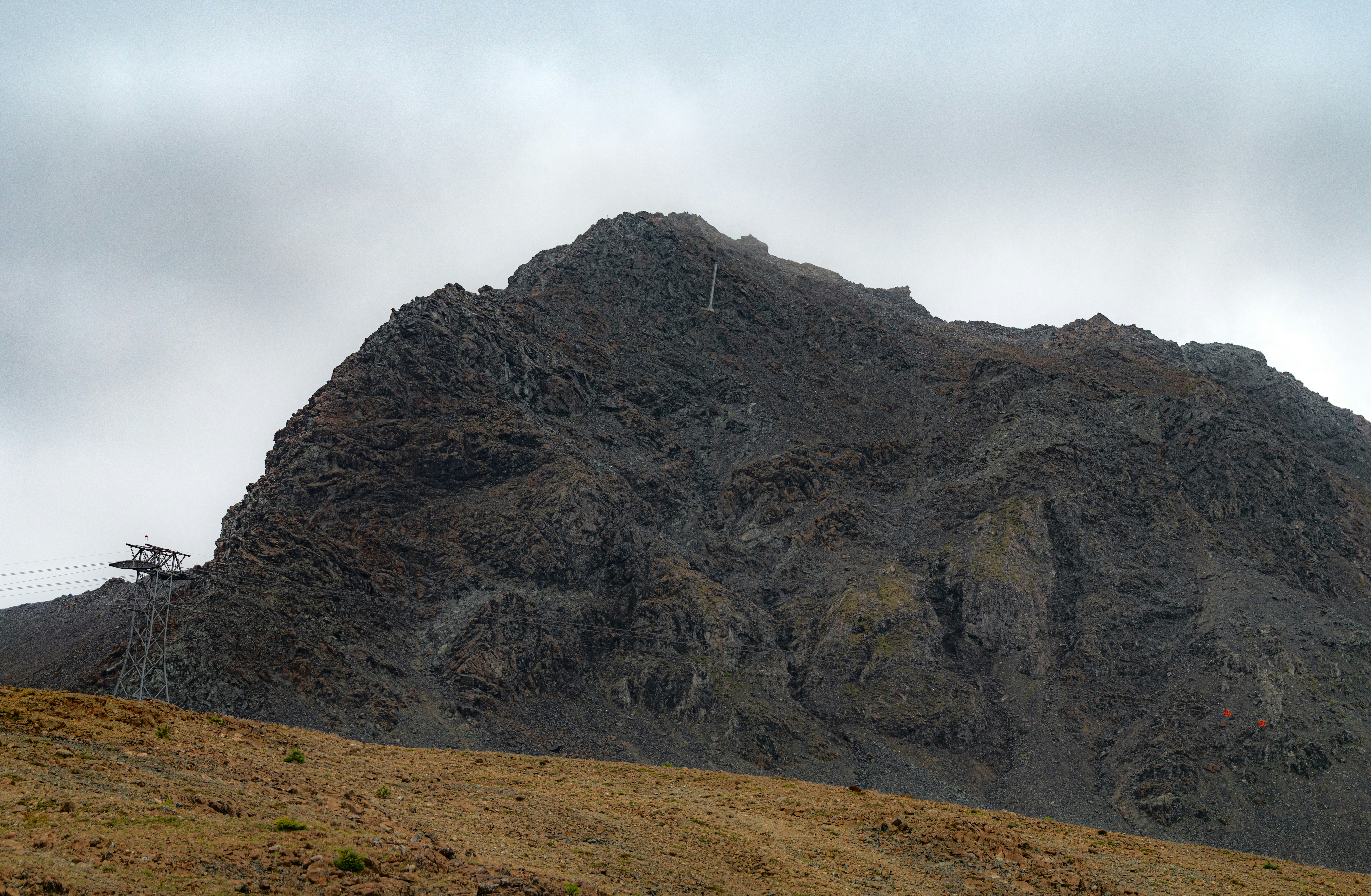 Rugged volcanic escarpment under overcast sky