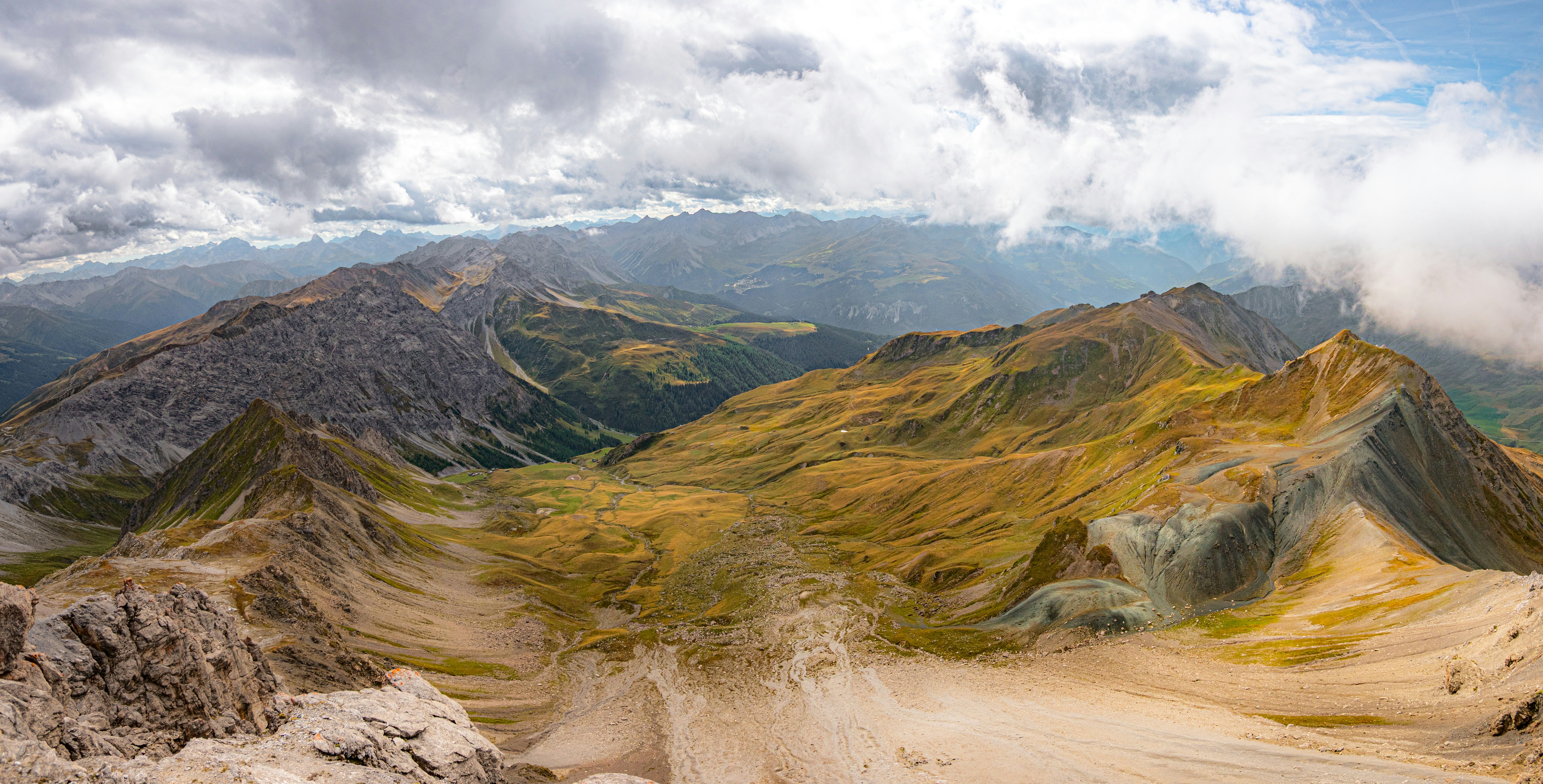 High Alpine Panorama: Golden Ridges Under Cloud-Cleared Skies