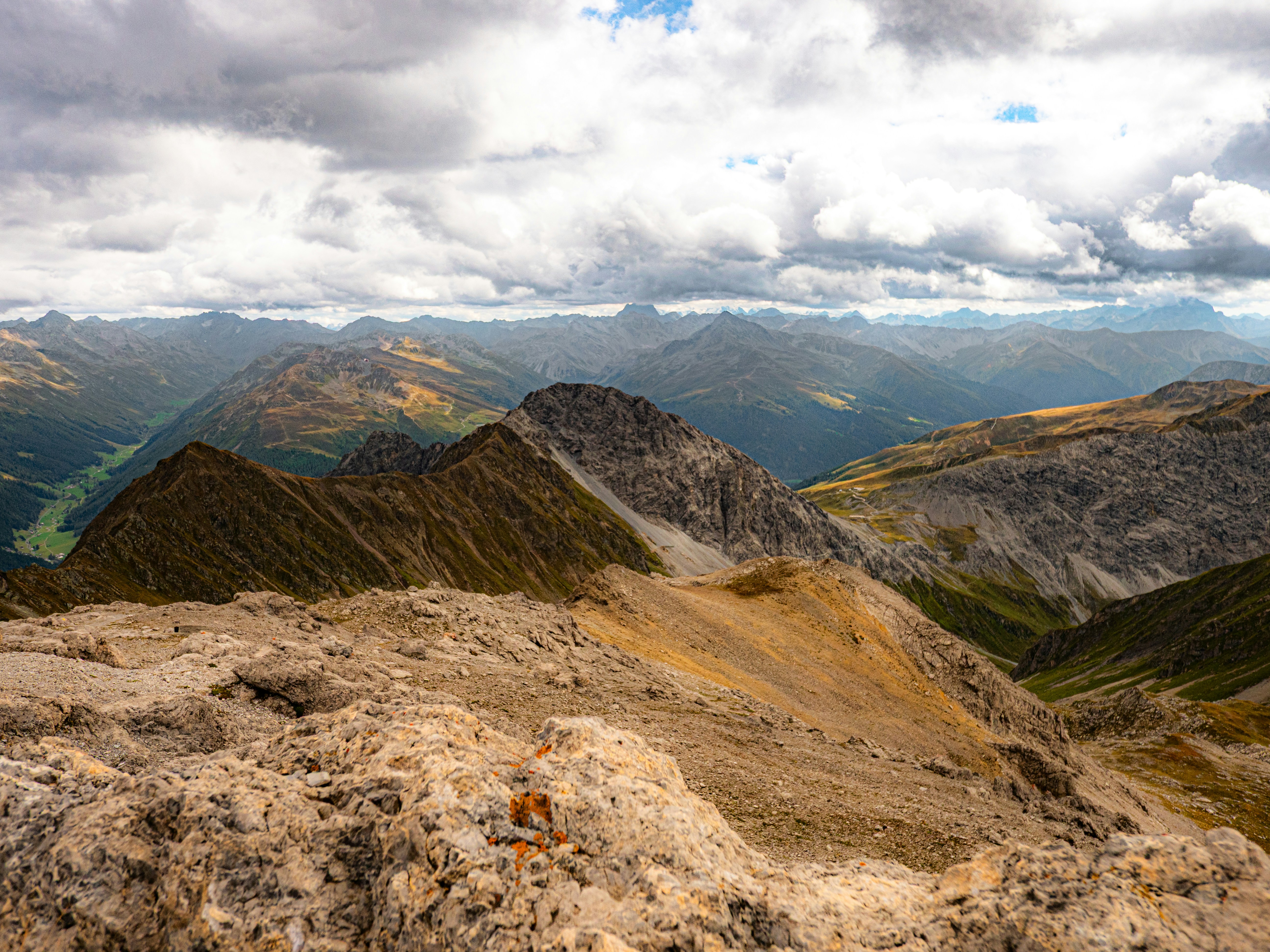 Ridgecrest Mosaic: Alpine Promontory Under Cumulus