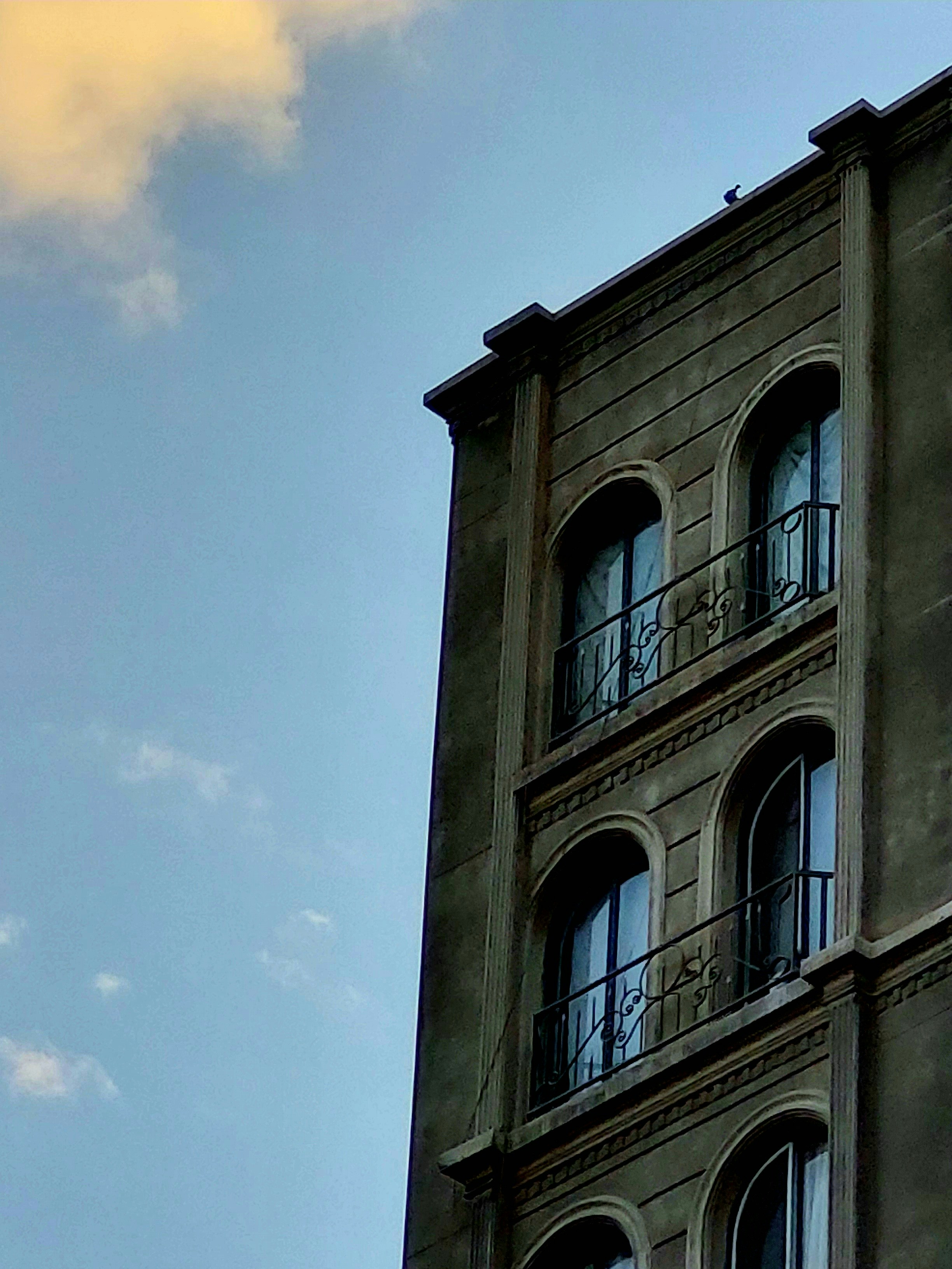 Facade Detail: A Corner Perspective of a Historic Building Against a Clear Sky