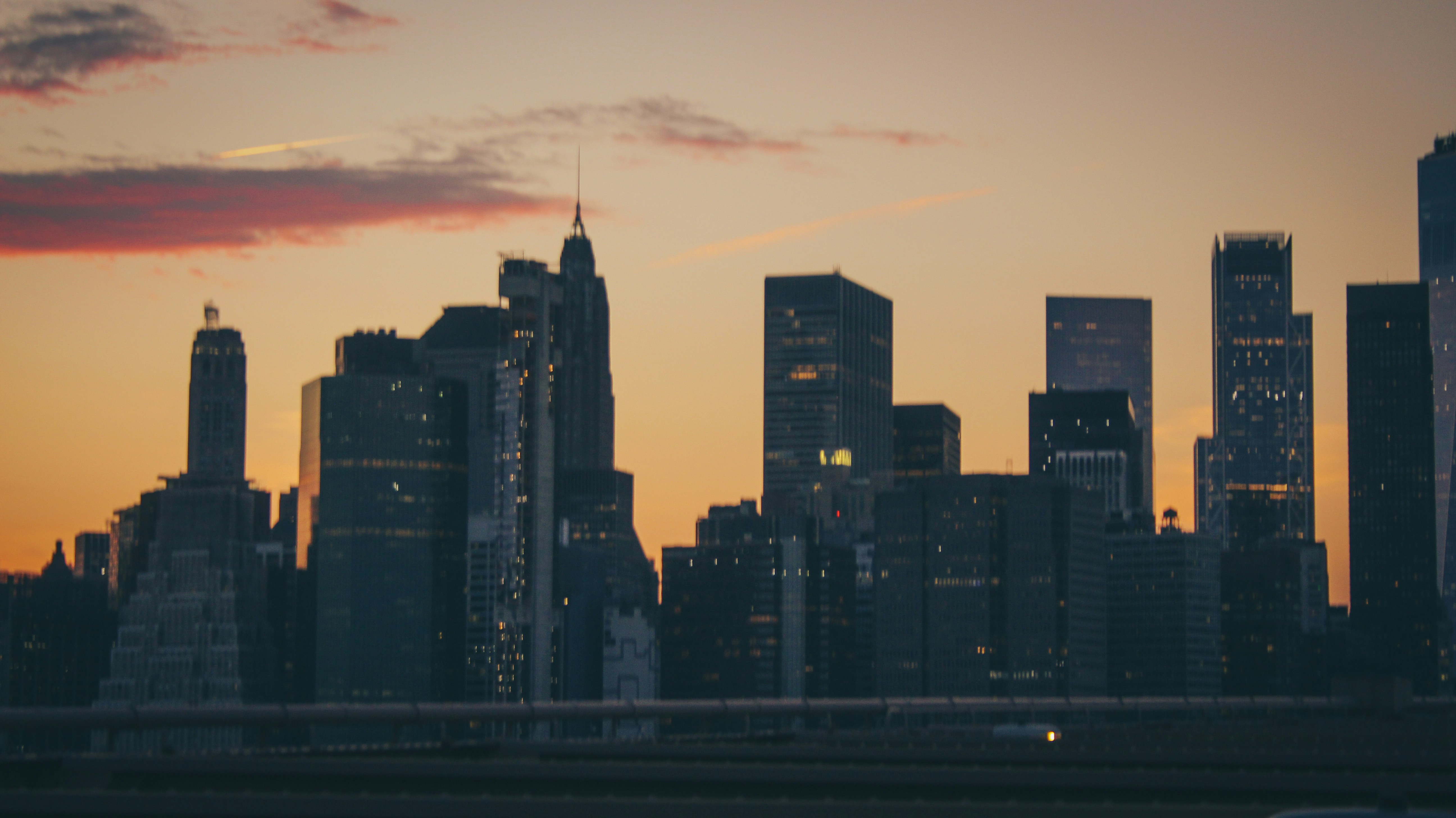 Dusk Over the City Arc: A Silhouette of Skyscrapers in Warm Neon