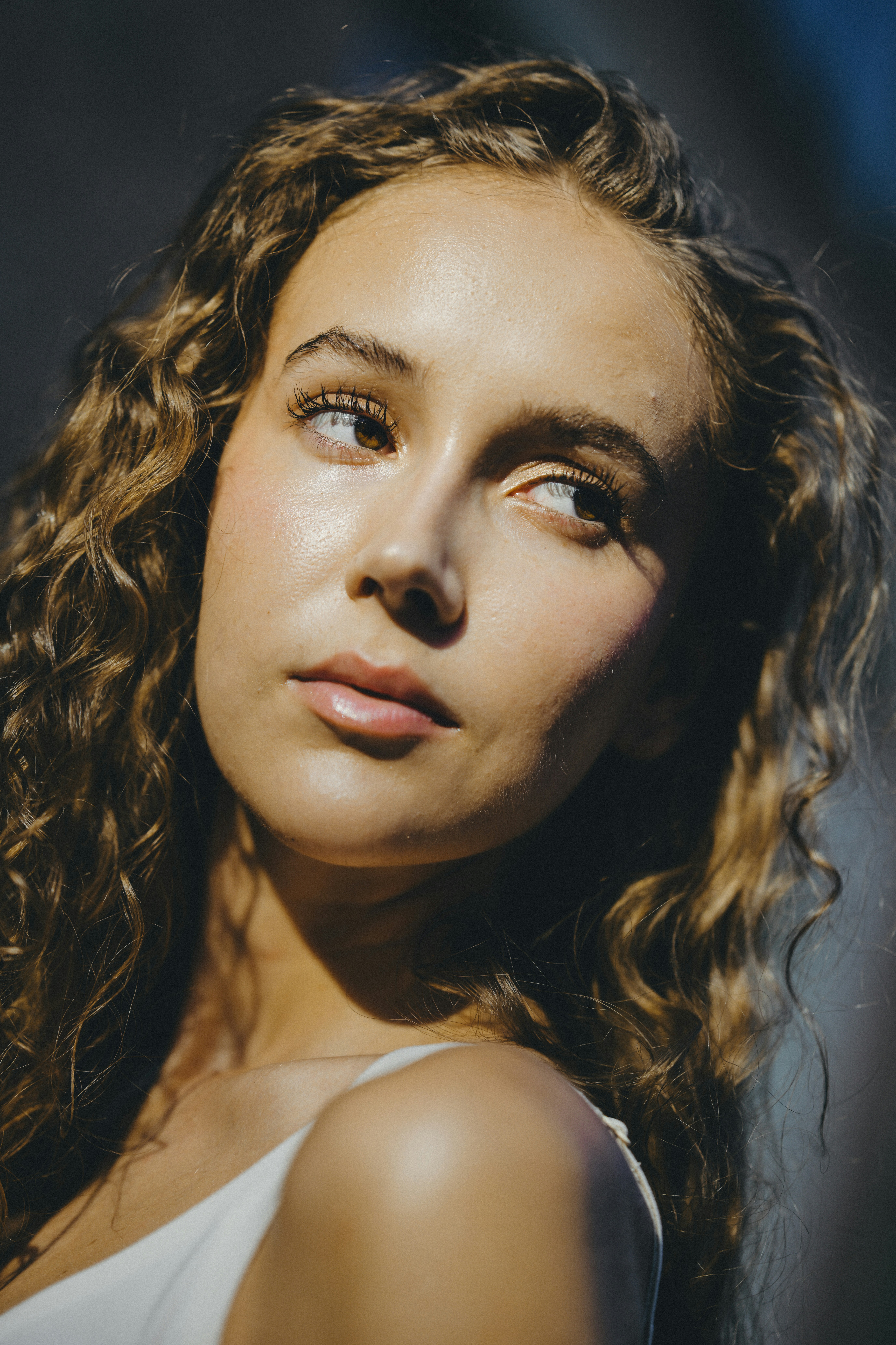 Soft Spotlight on a Curled-Hair Portrait