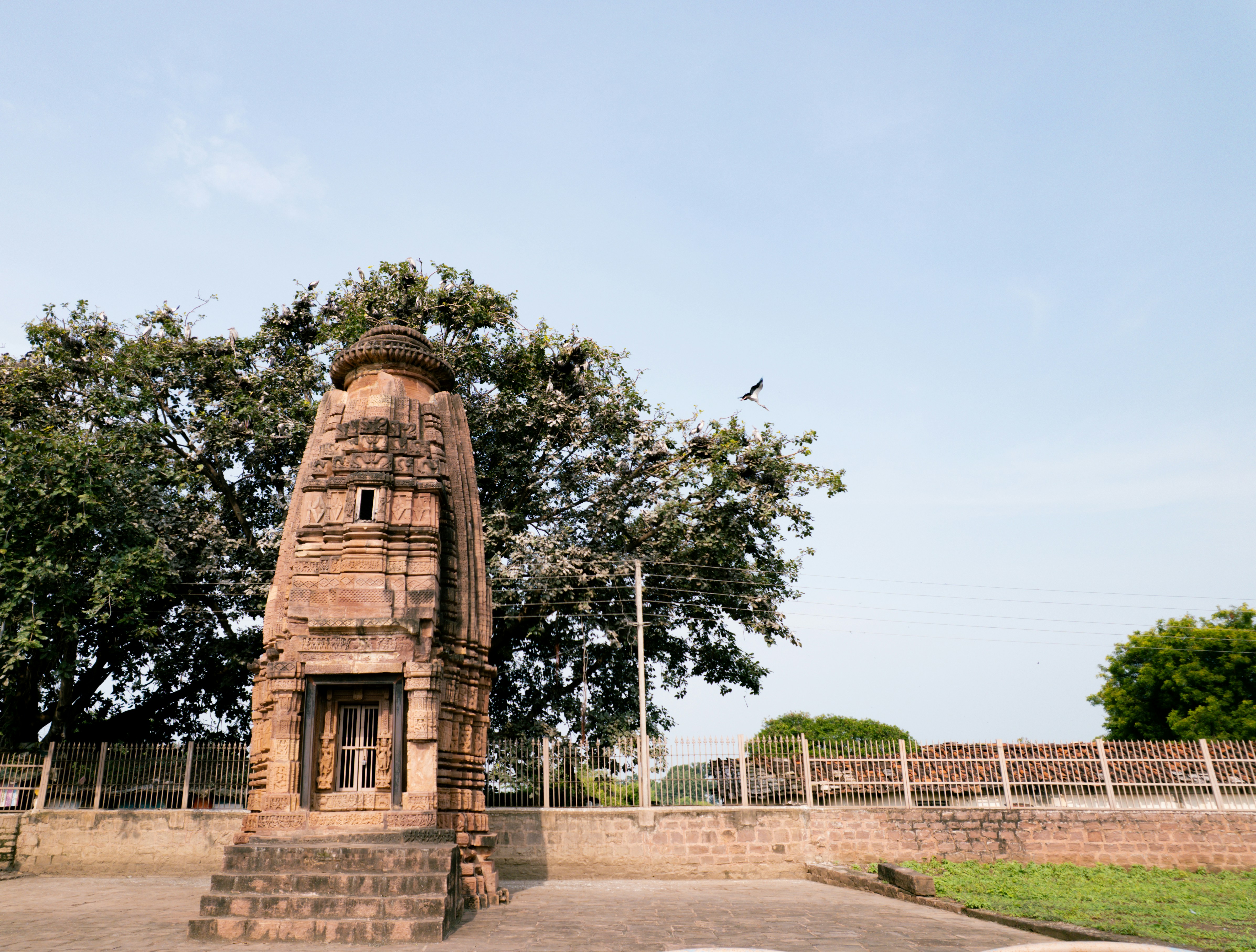 Stone Miniature Shrine Anchored by a Quiet Park