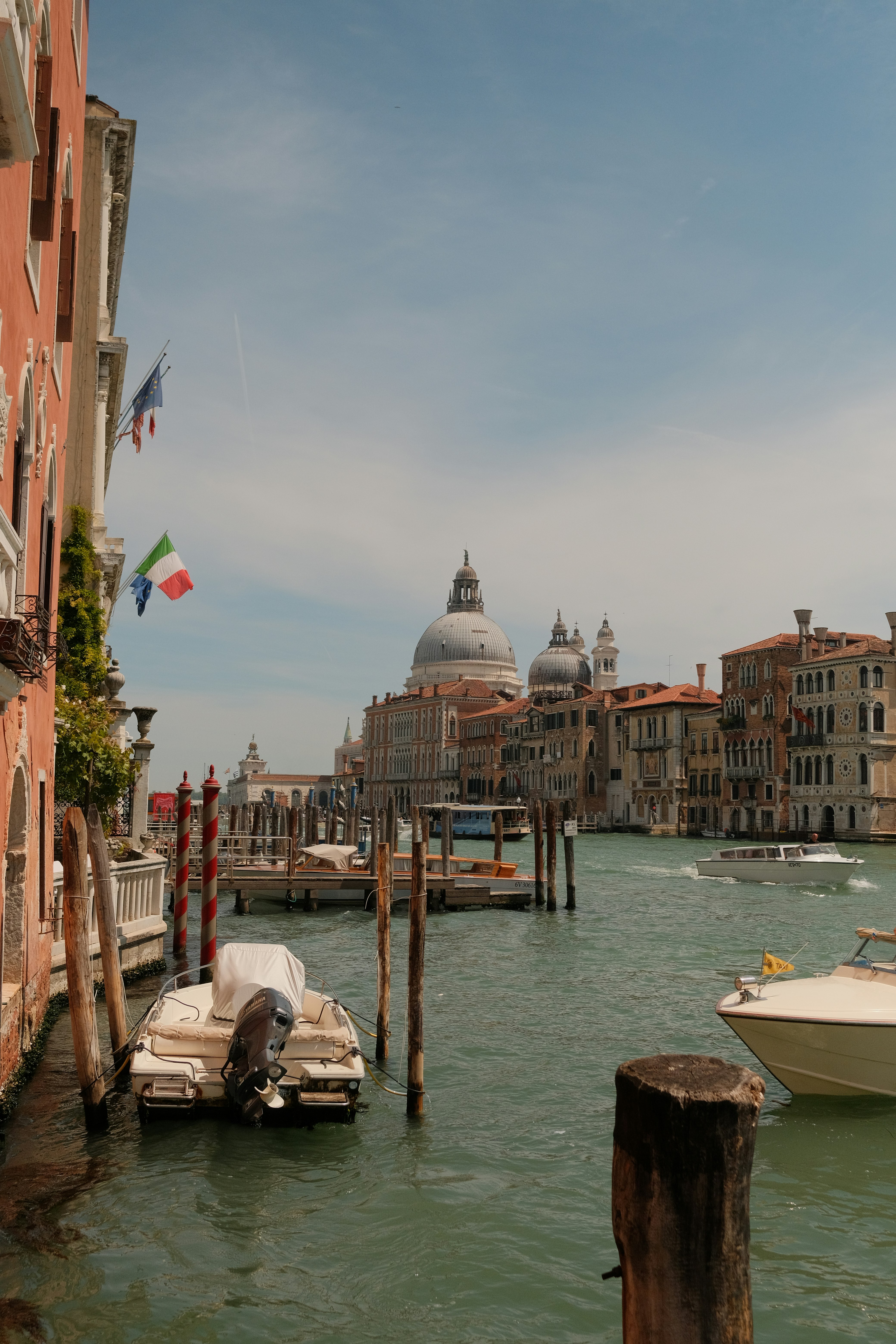 Venetian Canal Quiet: Boats Biding Time Along a Warm Italian Afternoon