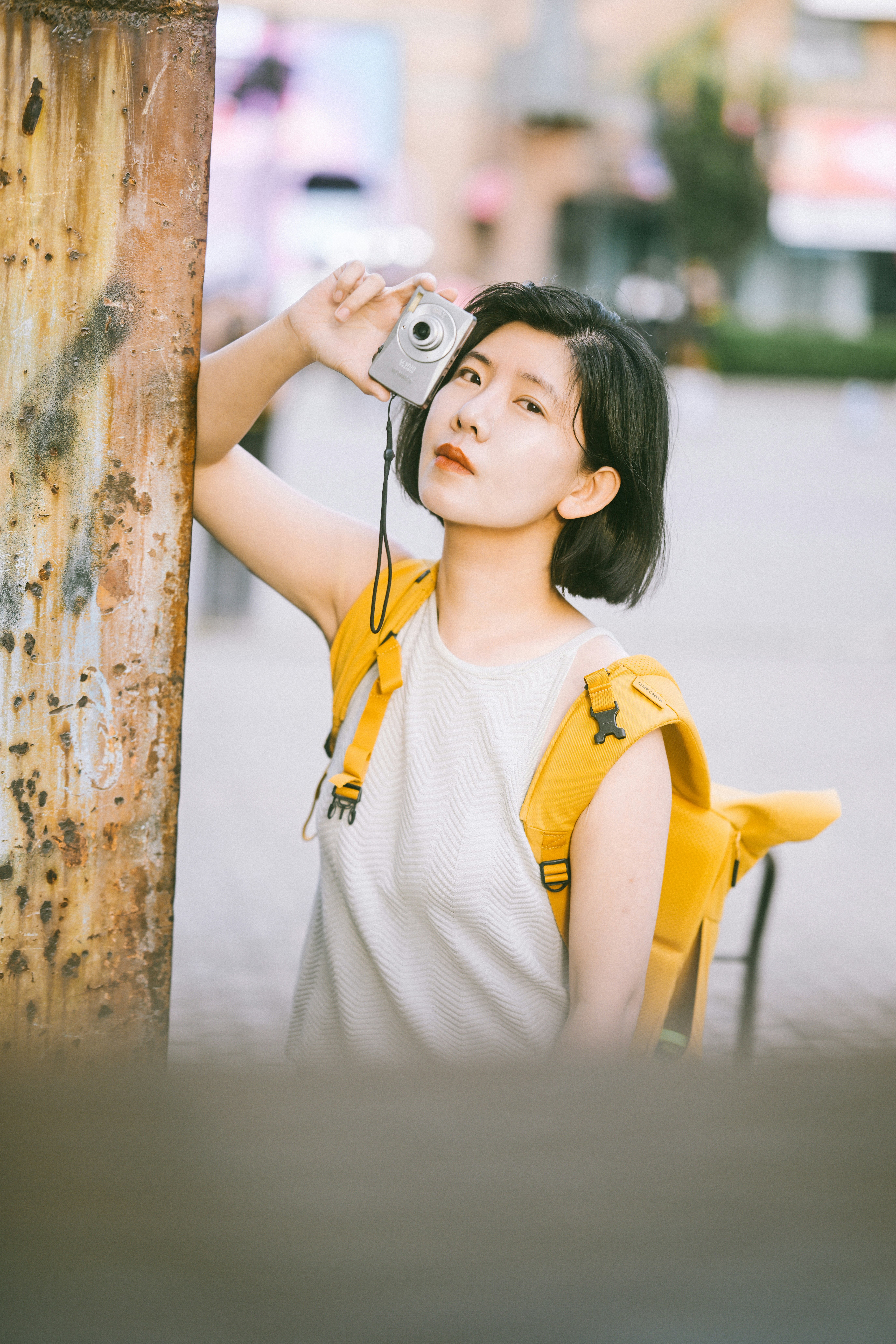 Yellow Backpack, Quiet Gaze: A Street Portrait with a Retro Moment