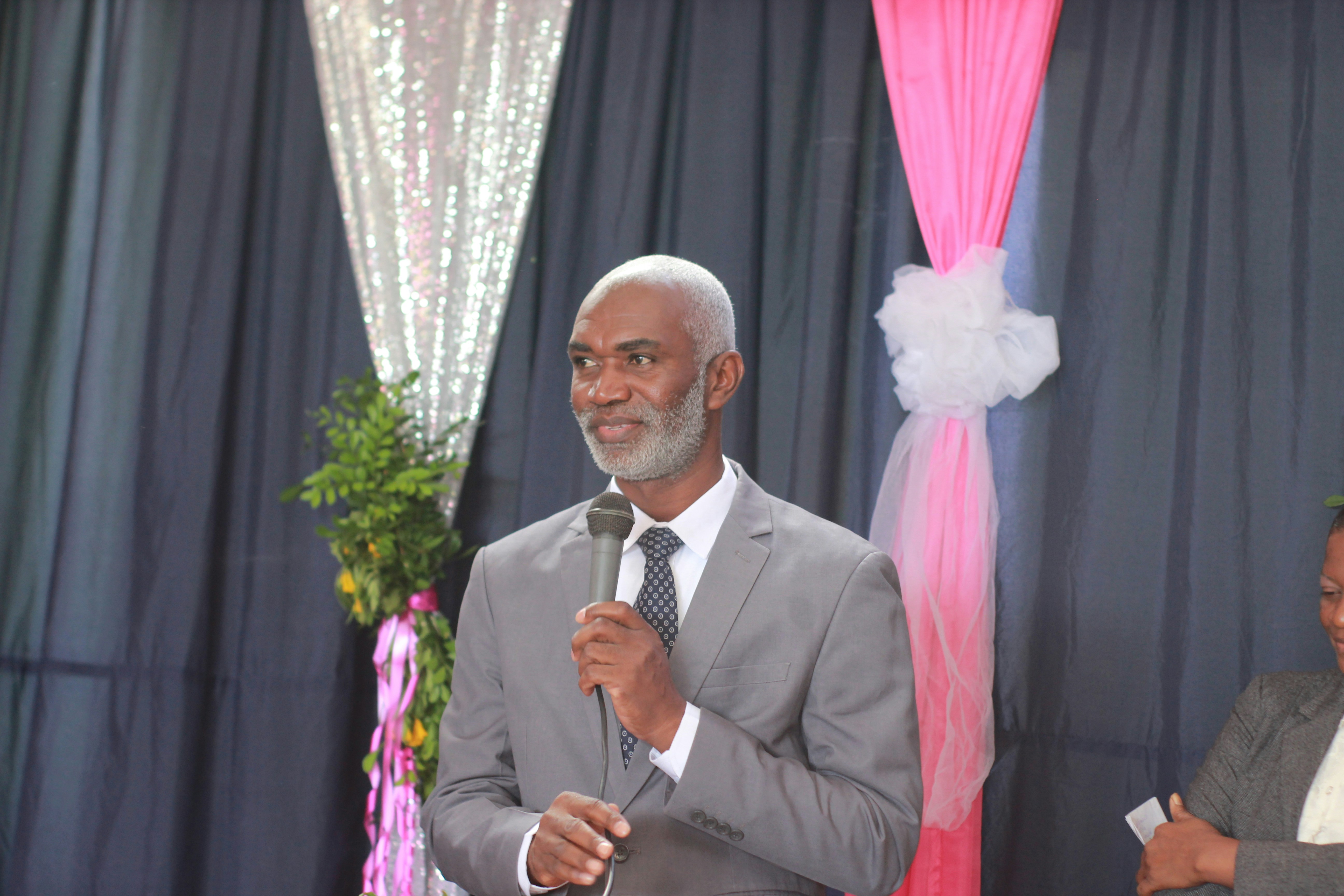 Middle‑Aisle Moment: The Speaker in a Gentle Gray Suit