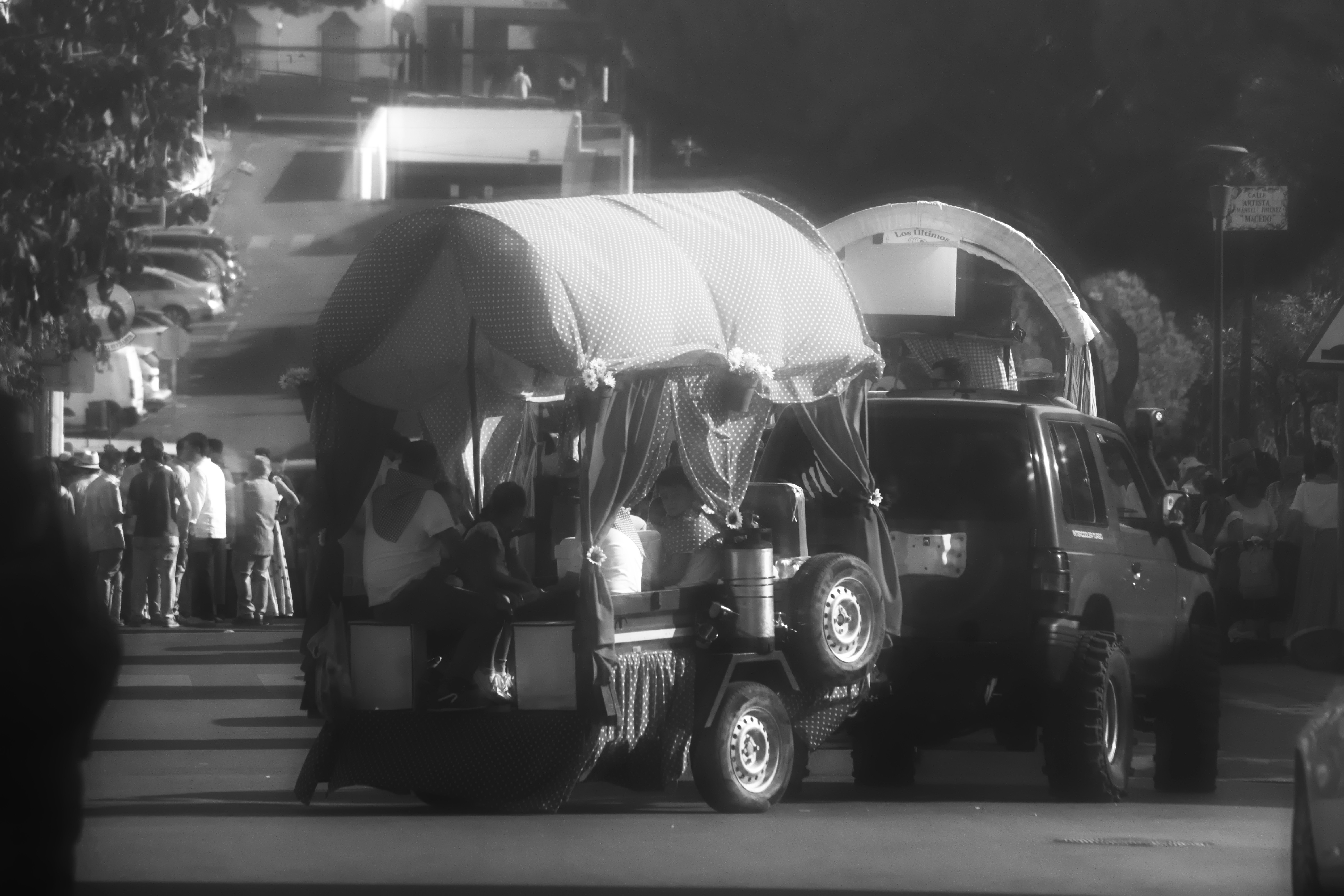 Covered Wagon Convoy: A Busy Street Scene in Muted Light