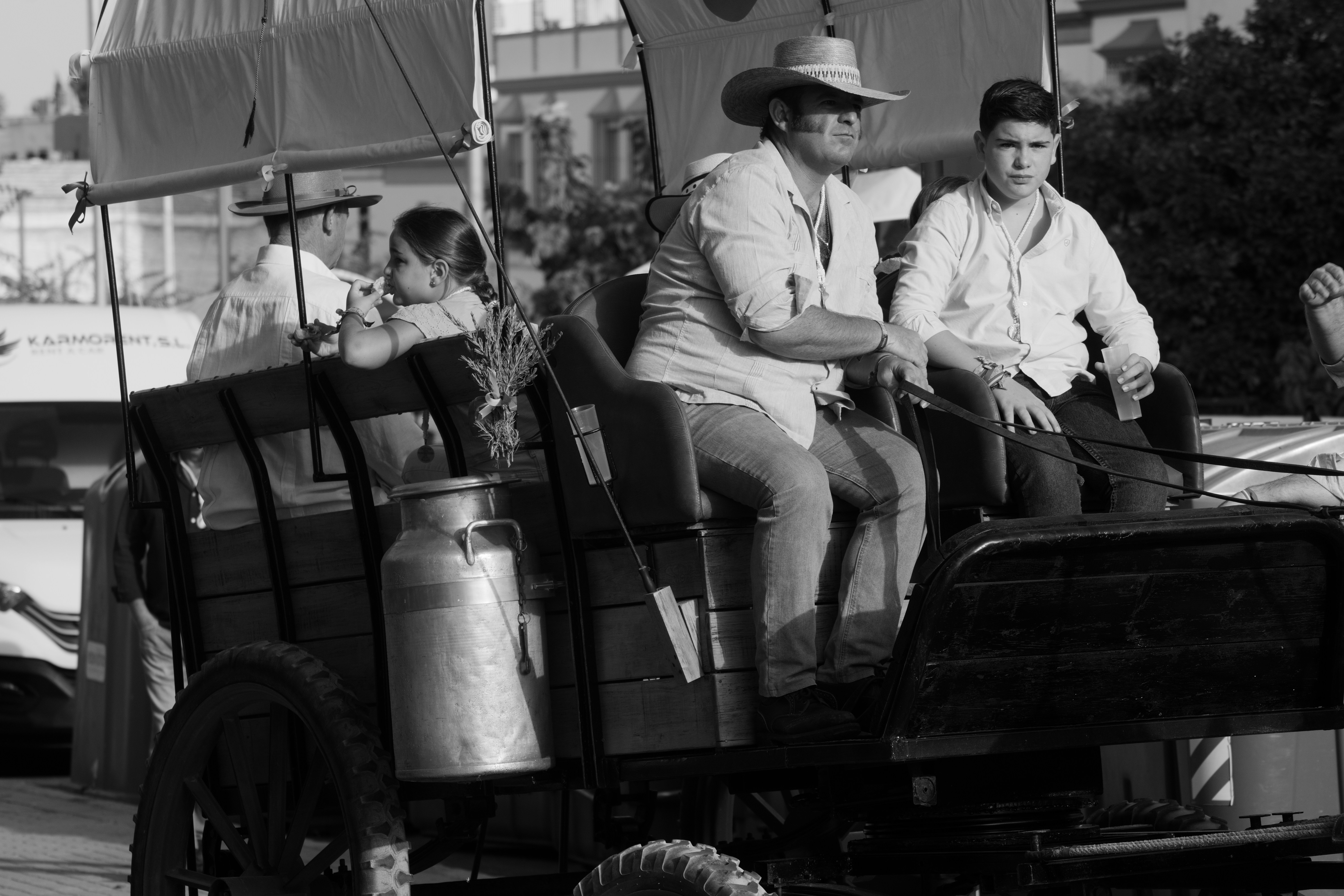 Horse-drawn parade at dusk: a trio on the wagon