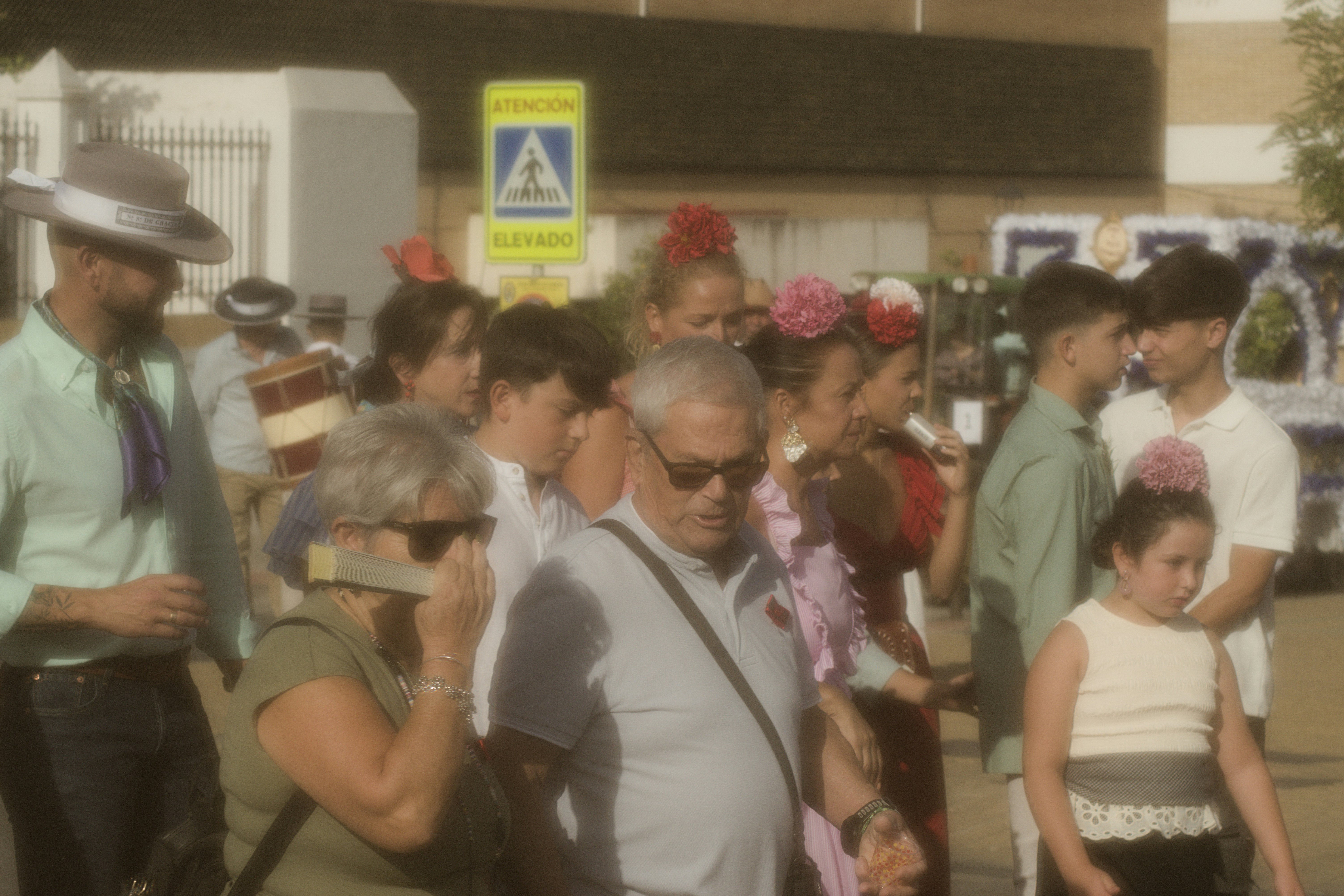 Crowd at a Festive Procession: Flowers, Hats, and Hats Off