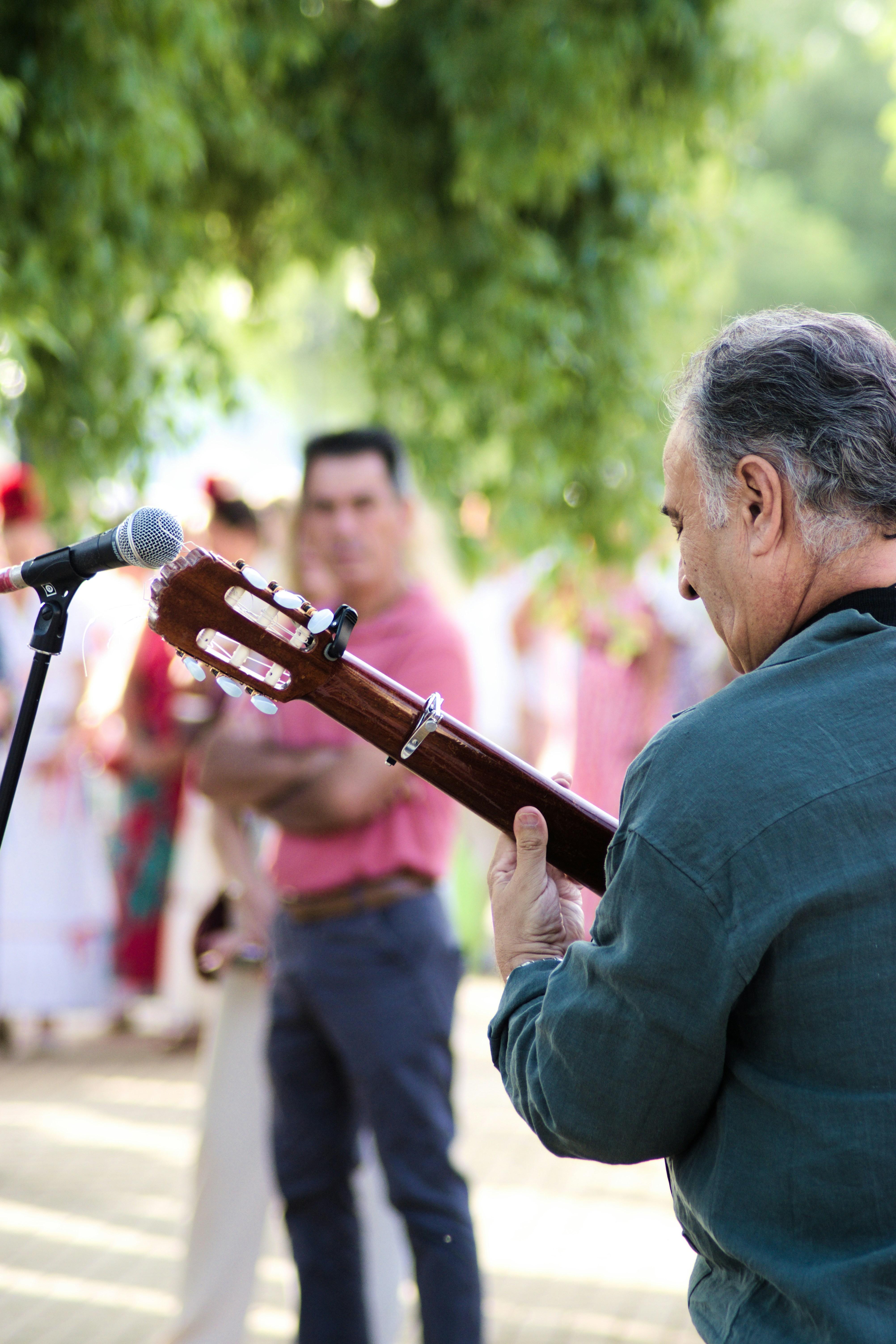 Guitarist in Focus: A Moment of Sound Amid a Hushed Crowd
