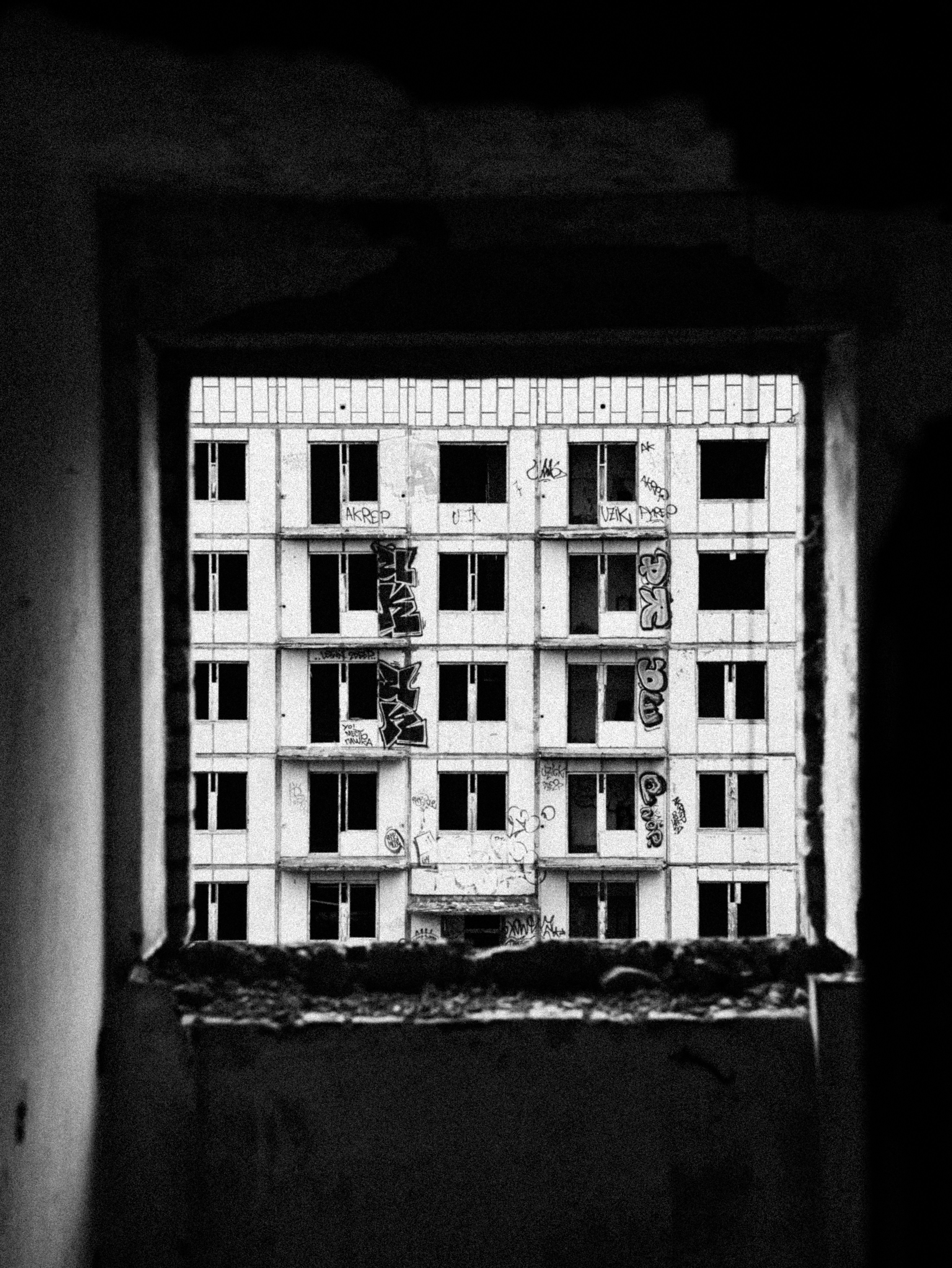Through a Crumbling Window: Annihilated Facade in Monochrome Silence