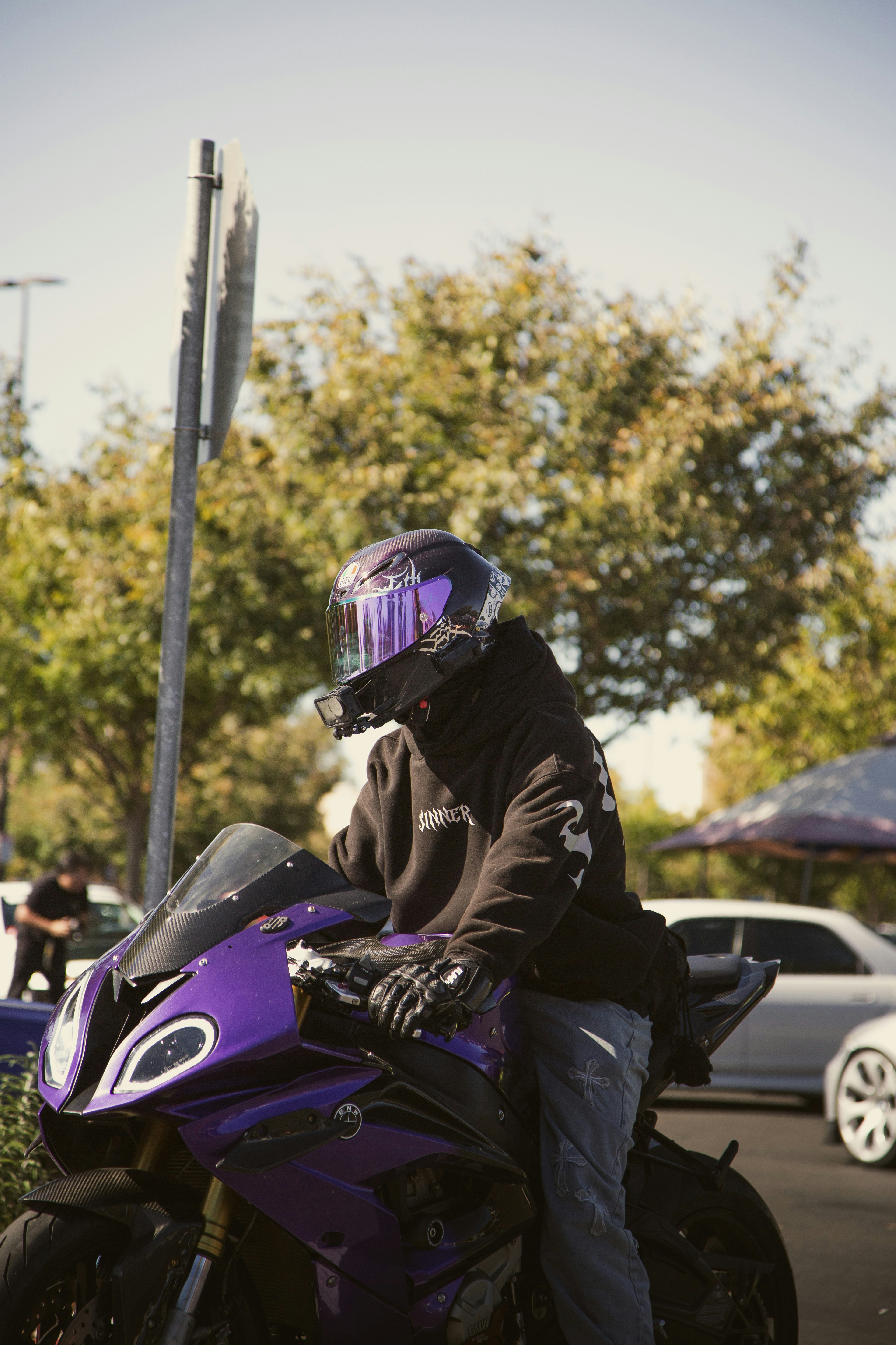 Rider in Purple: Street Meet on a Sunny Afternoon