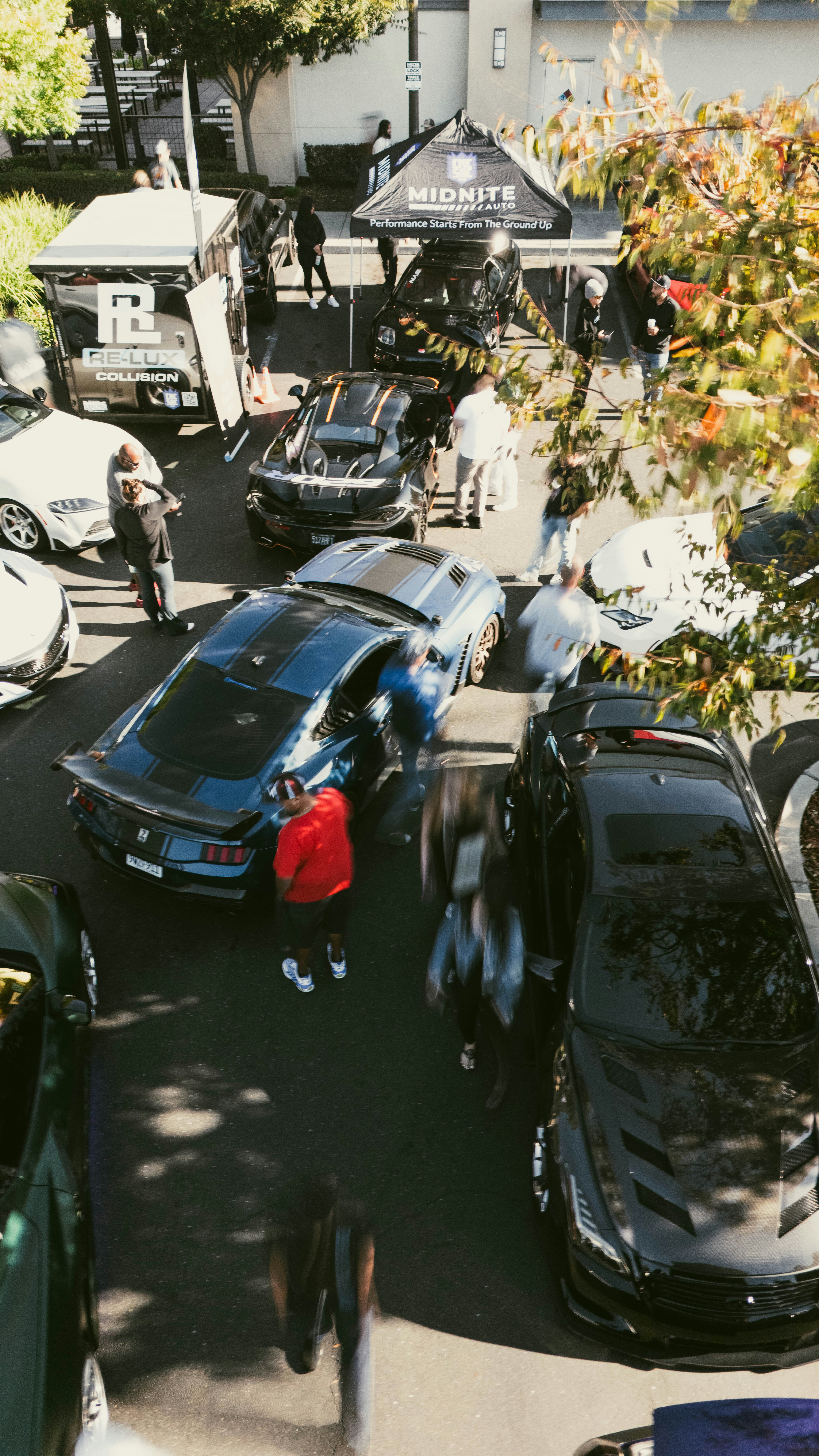 Midday Car Show: Aerial Bustle Beneath a Racing Canopy
