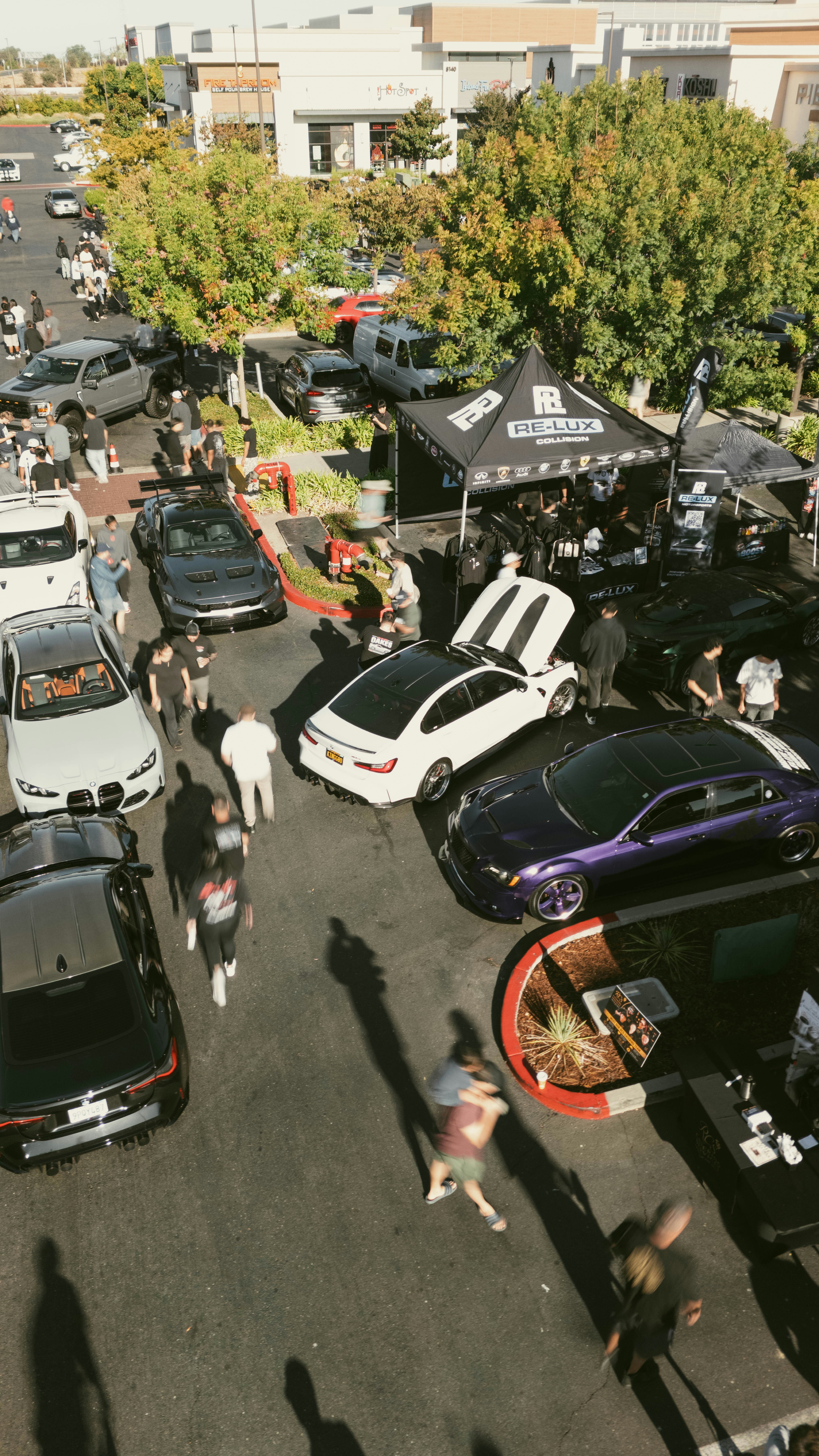 Sunlit Car Show in a Bustling Lot