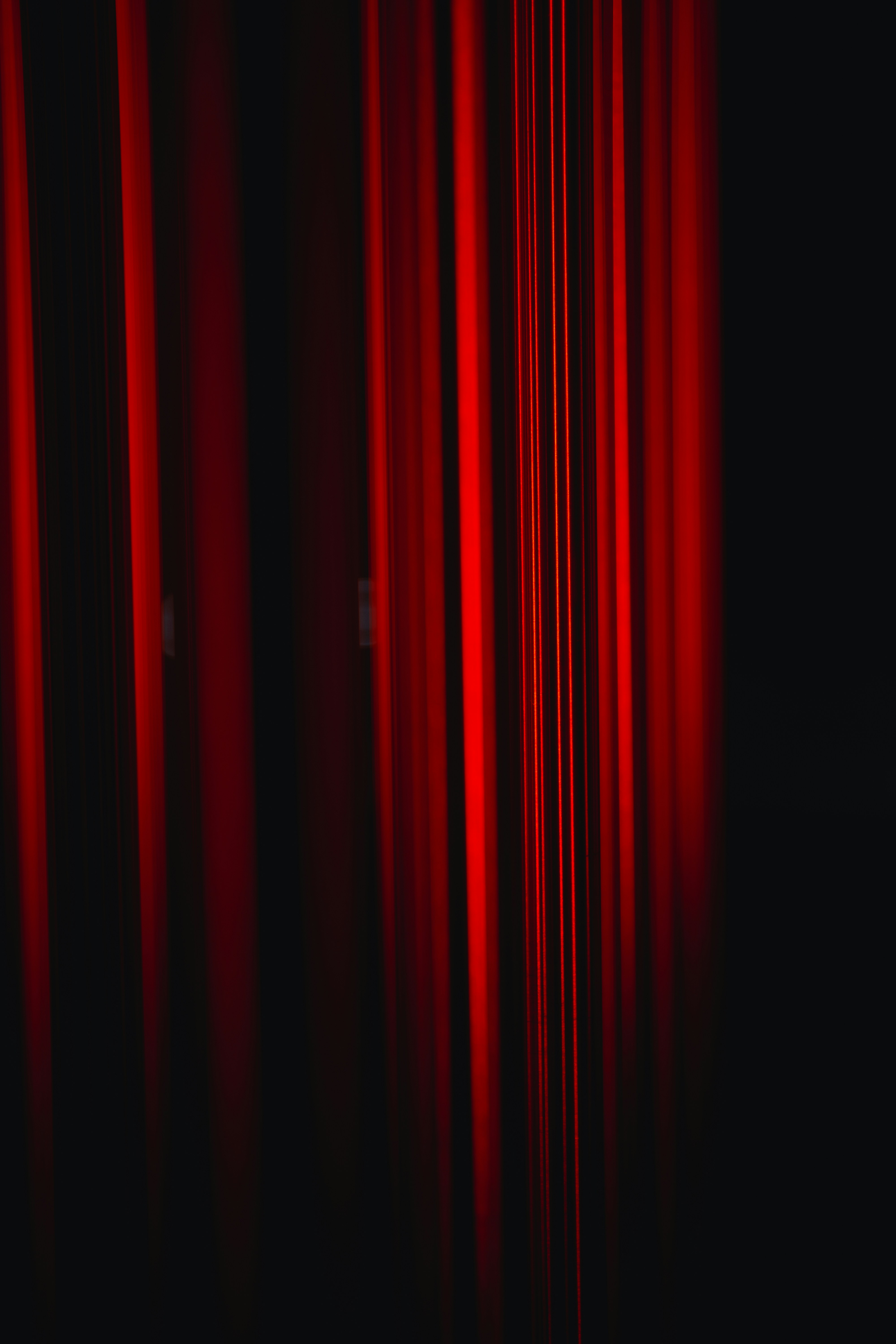 Crimson Corridor: Vertical Streaks of Light in a Velvet Night