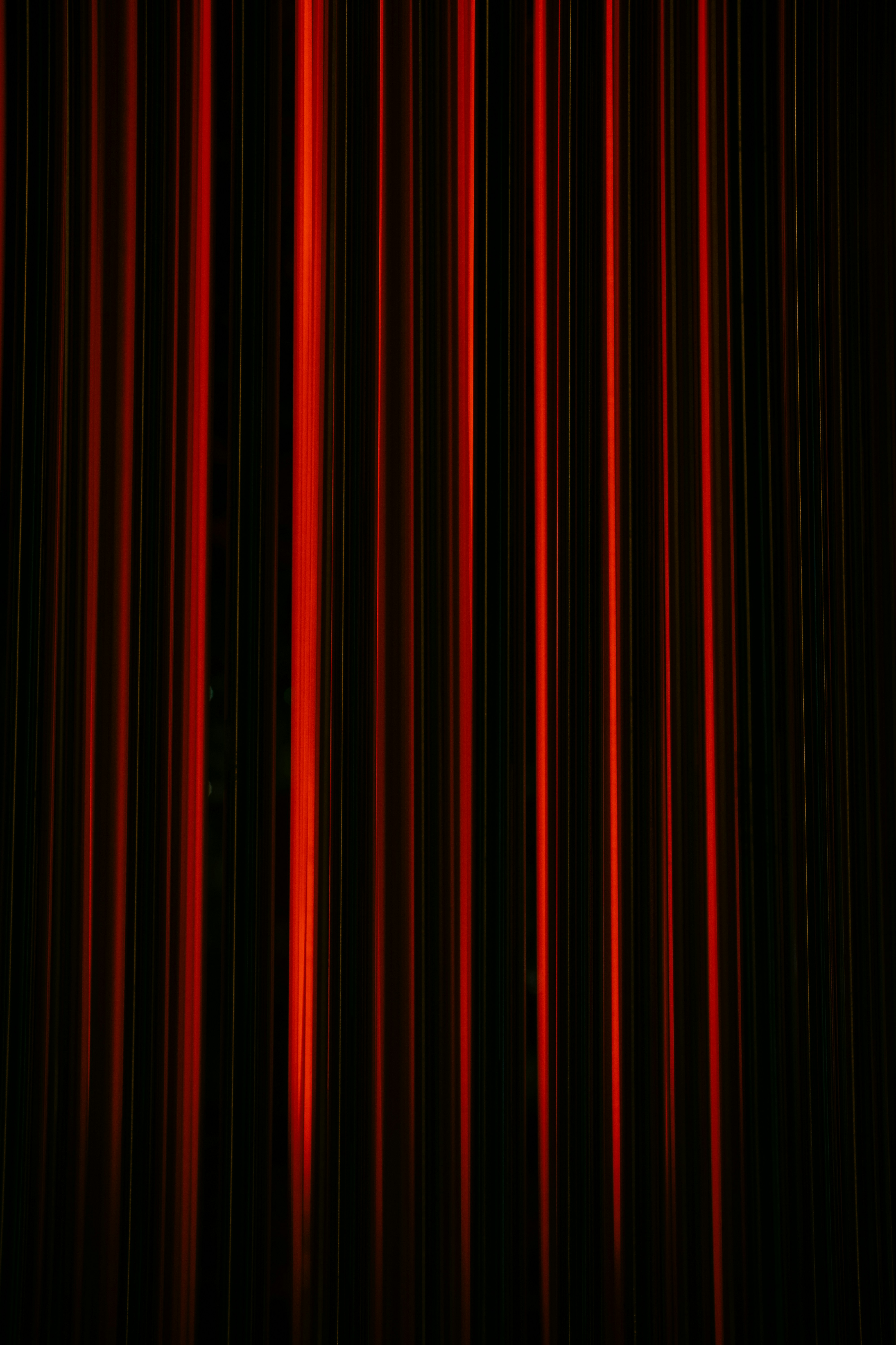 Scarlet Streaks: Vertical Light Trails in Isolation