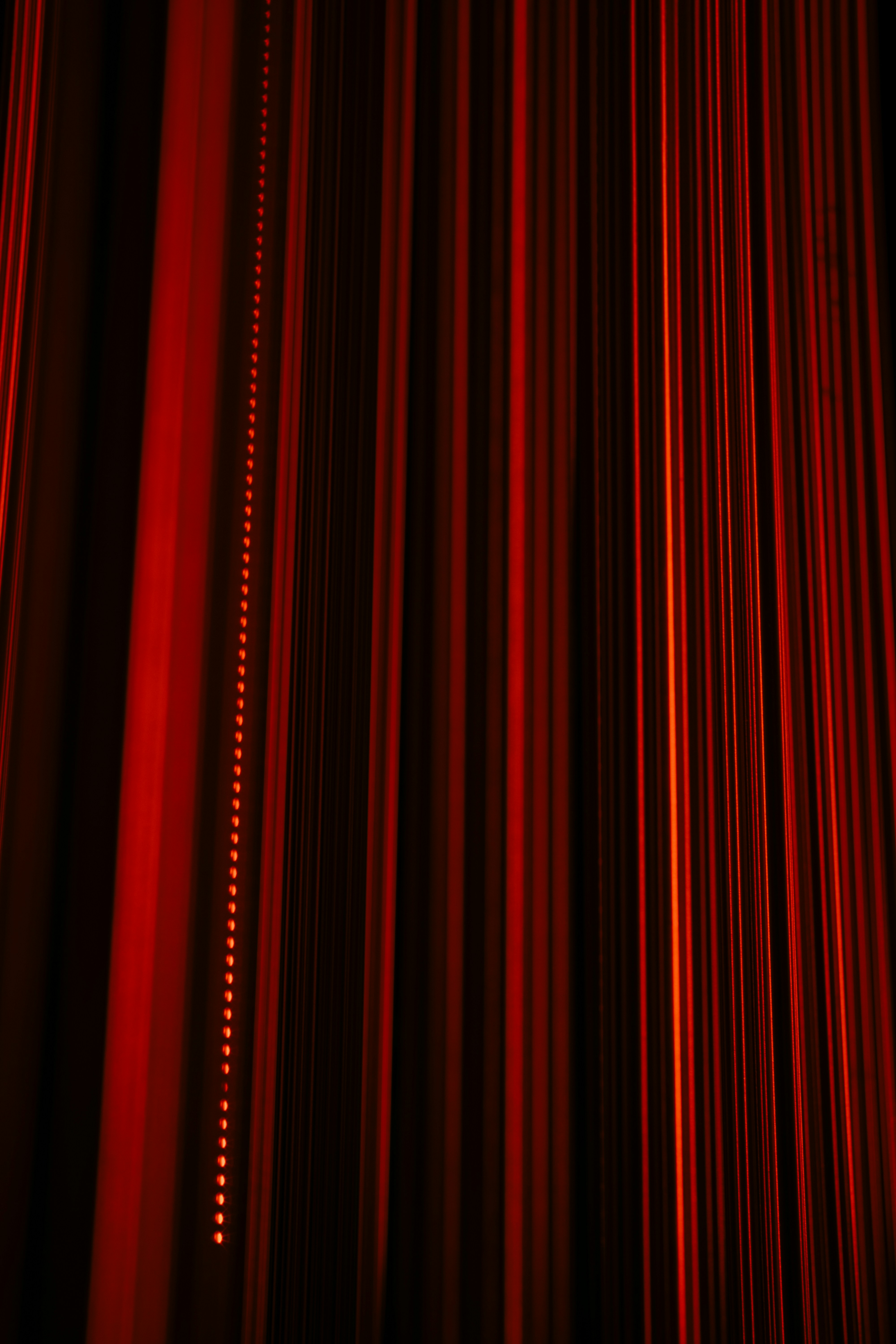 Crimson Echoes: Vertical Streaks of Light in a Dark Room