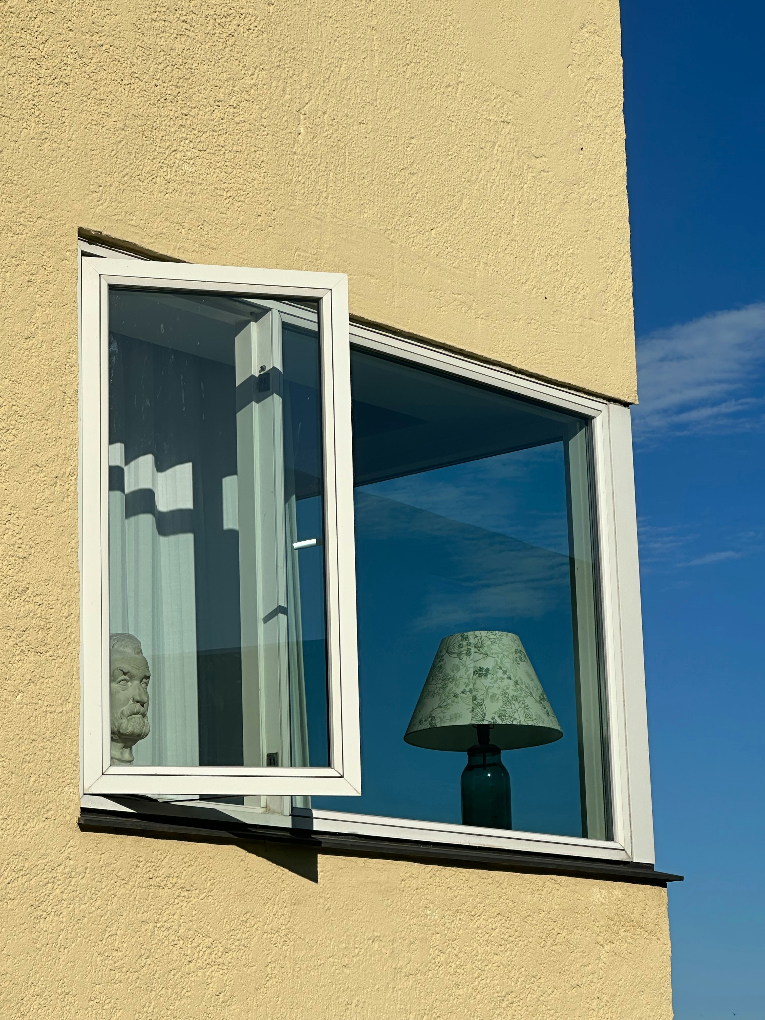 Window into a Quiet Interior: Lamp and Echoes of a Face
