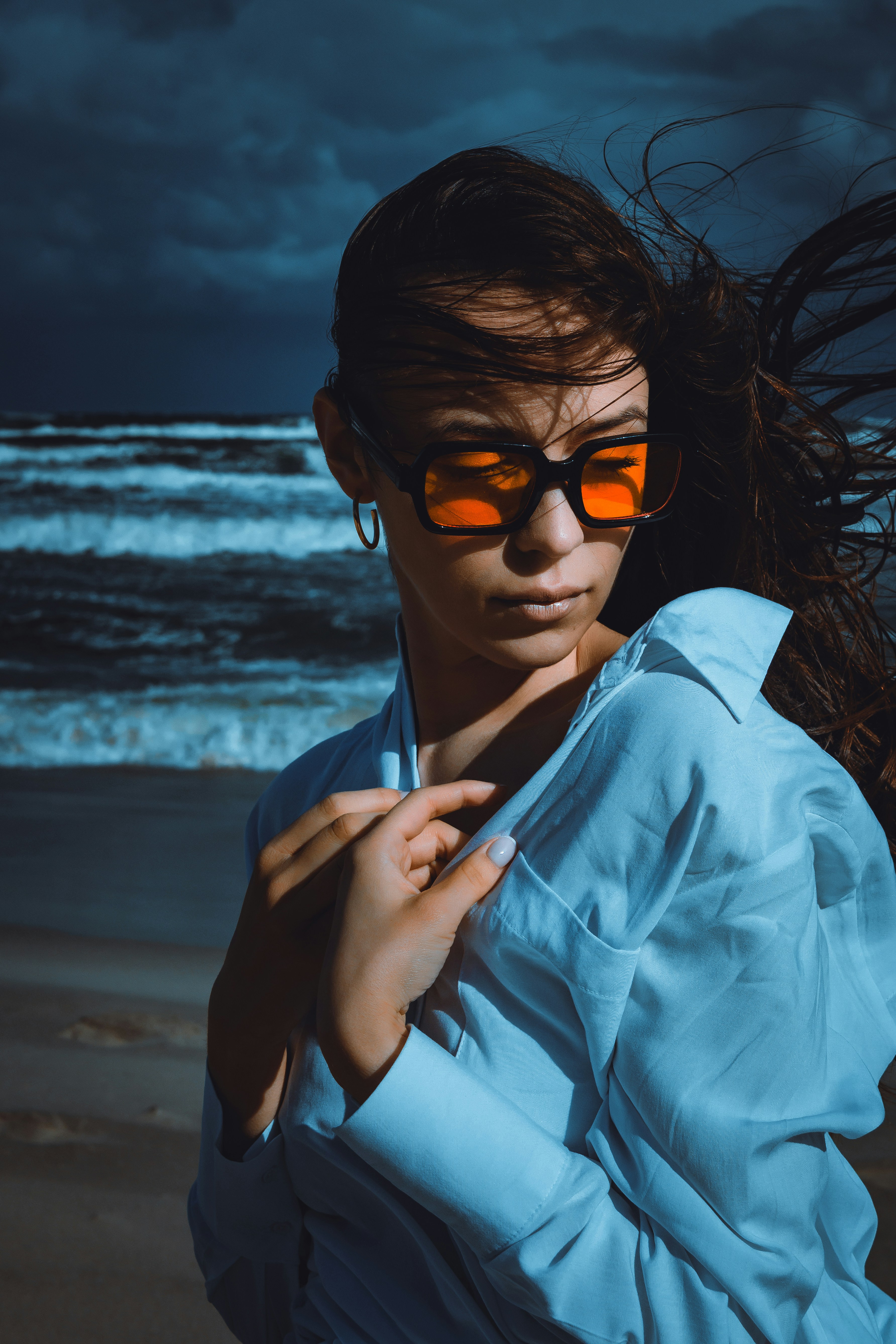 Glow in Orange: A Wind-Swept Portrait by the Shore