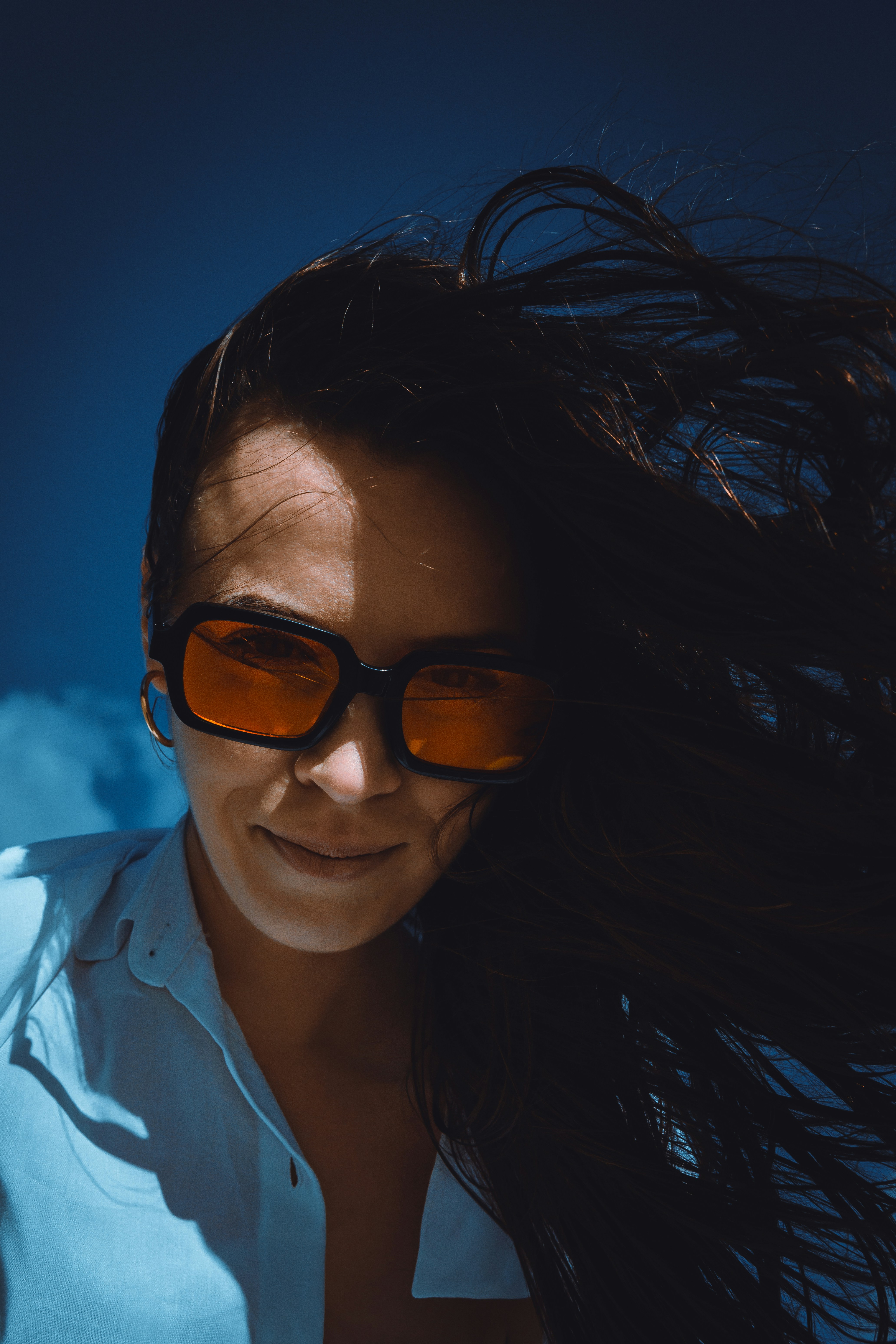 Wind in the Frame: Sunlit Portrait with Bold Orange Lens