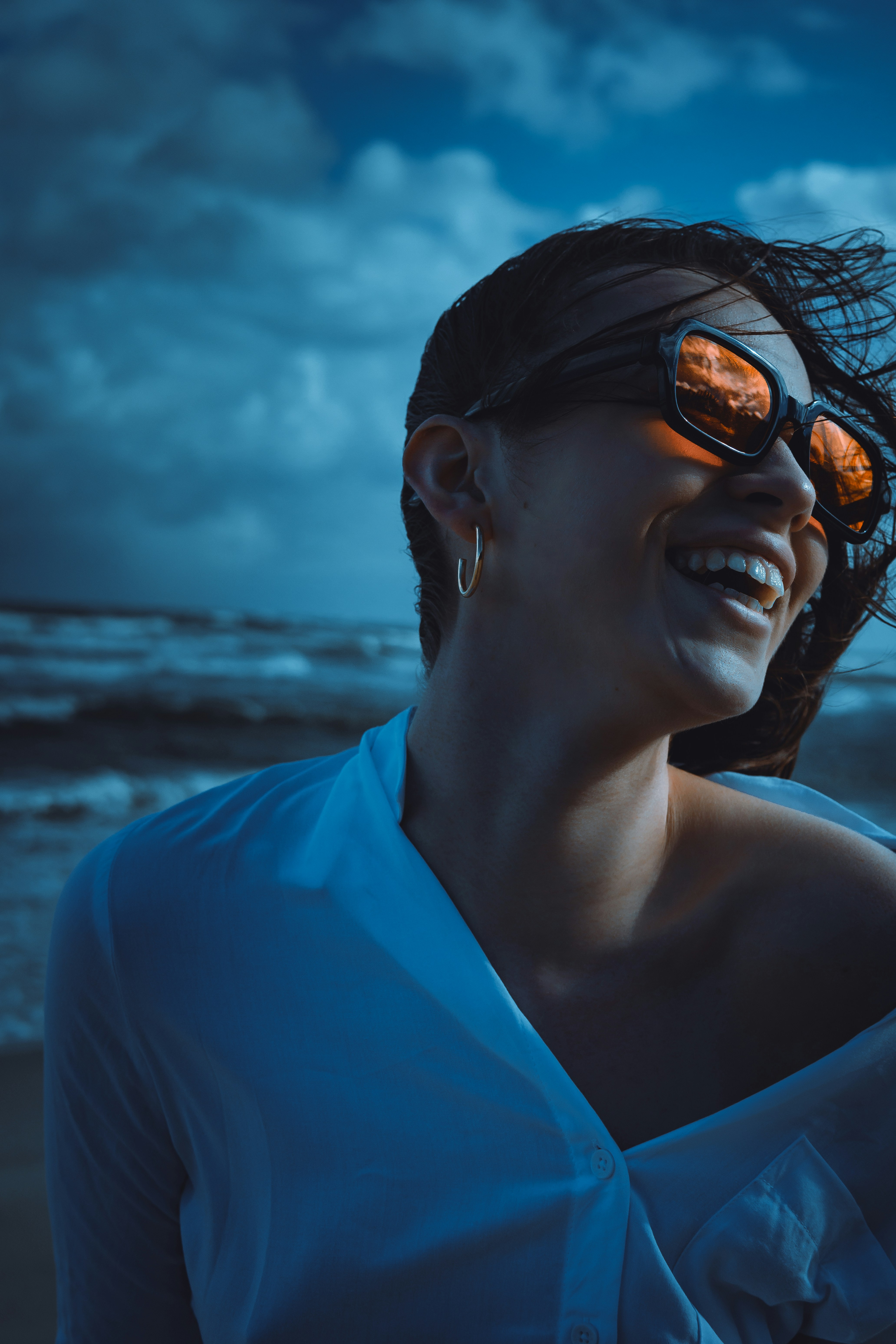Smiling in the Breeze: A Beach Portrait in Cool Tones