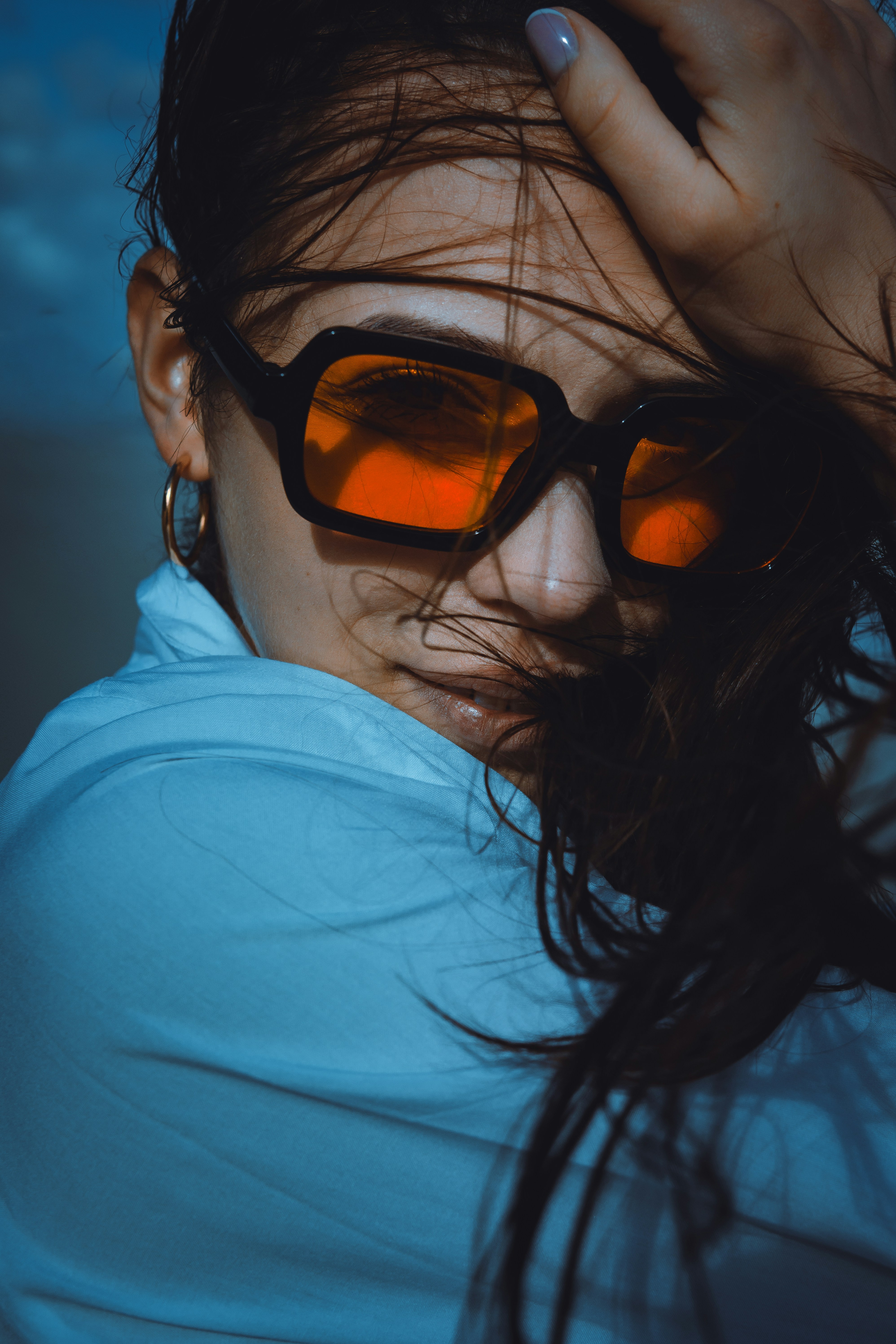 Orange-tinted mystery: a close-up of a shaded gaze