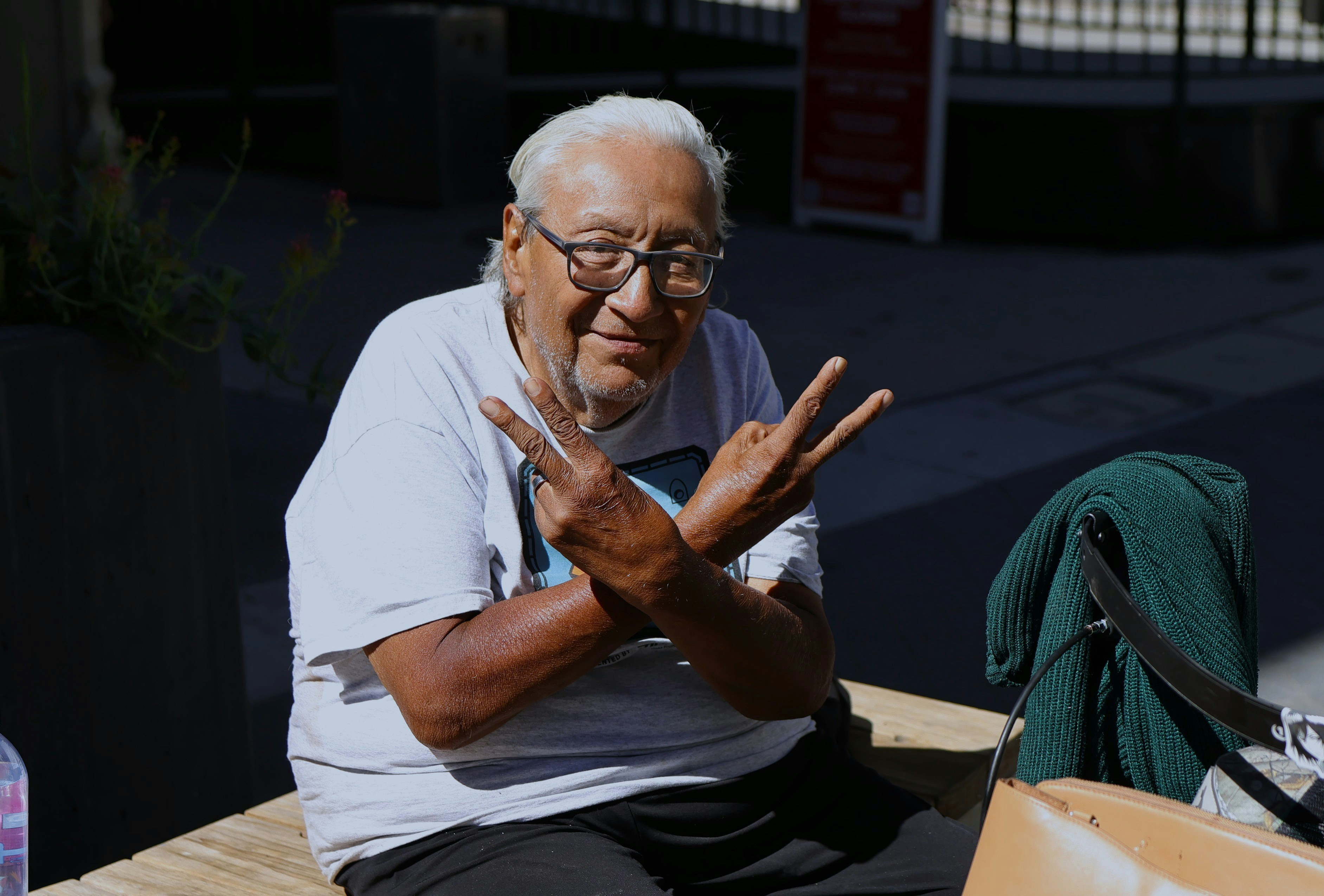 Smiling Gesture: A relaxed moment with an elderly man outdoors