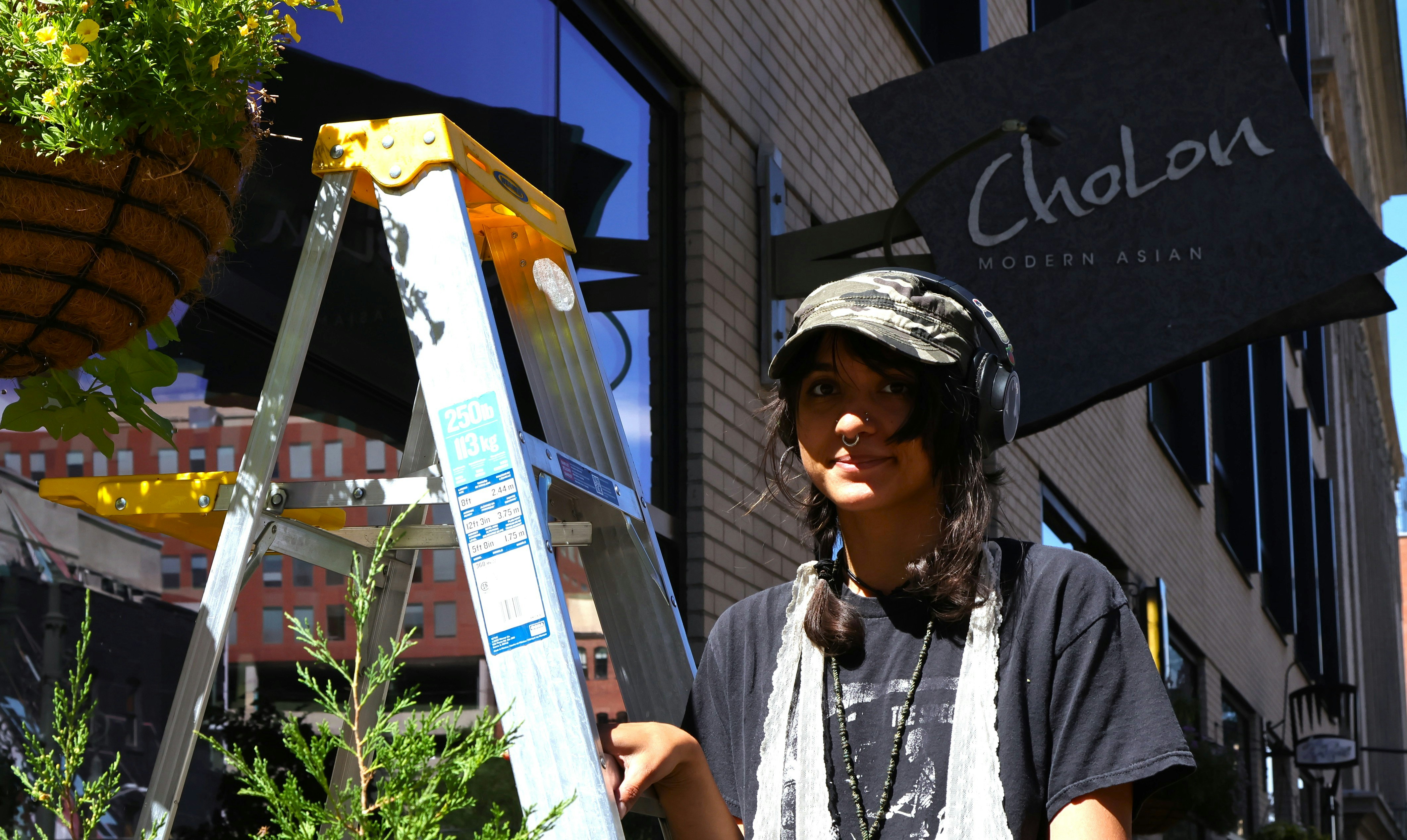 At the Ladder Edge: Street Styling Under a Canopy of Urban Signage