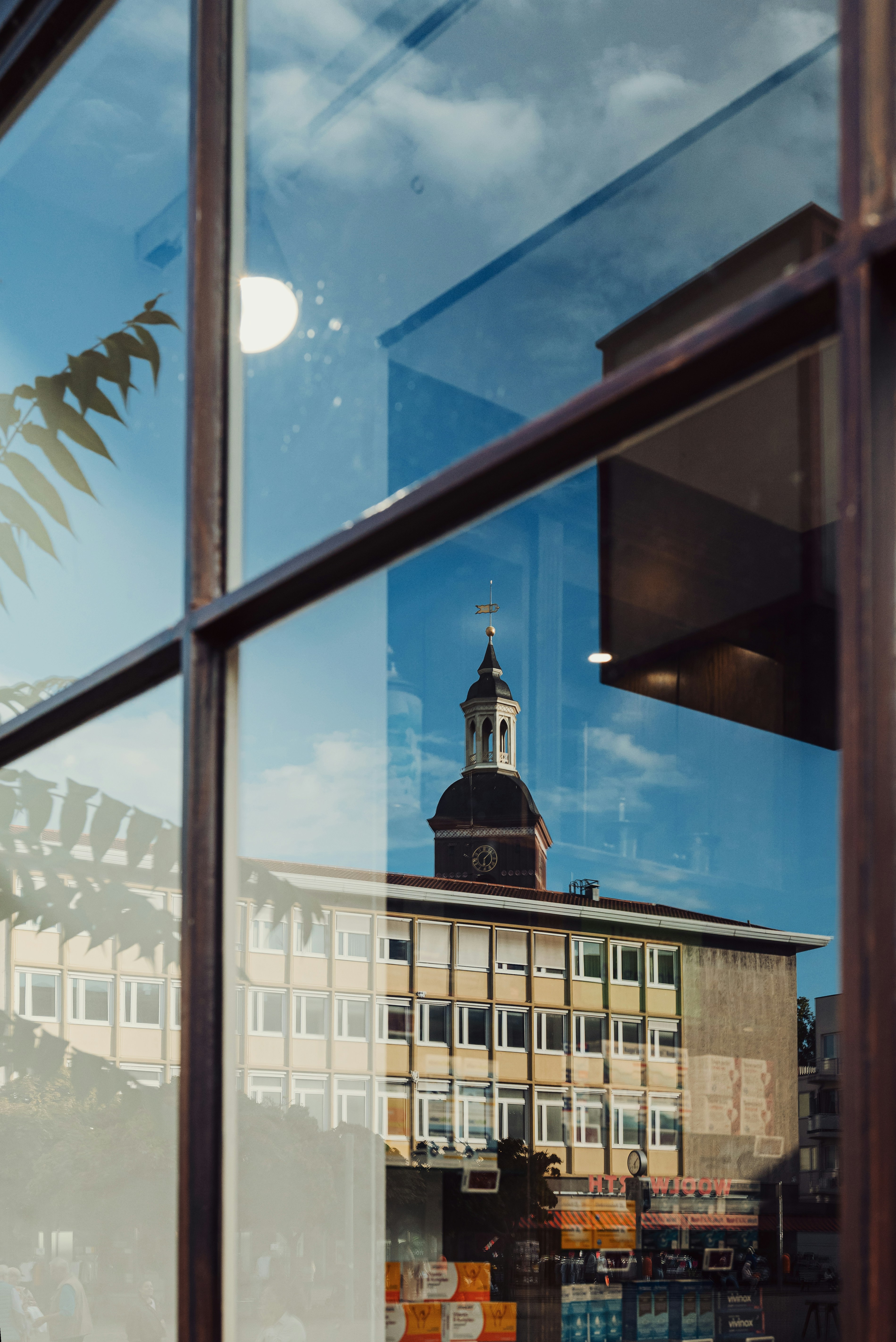 Clock Tower Reflections: Urban Facades Through a Glass Window