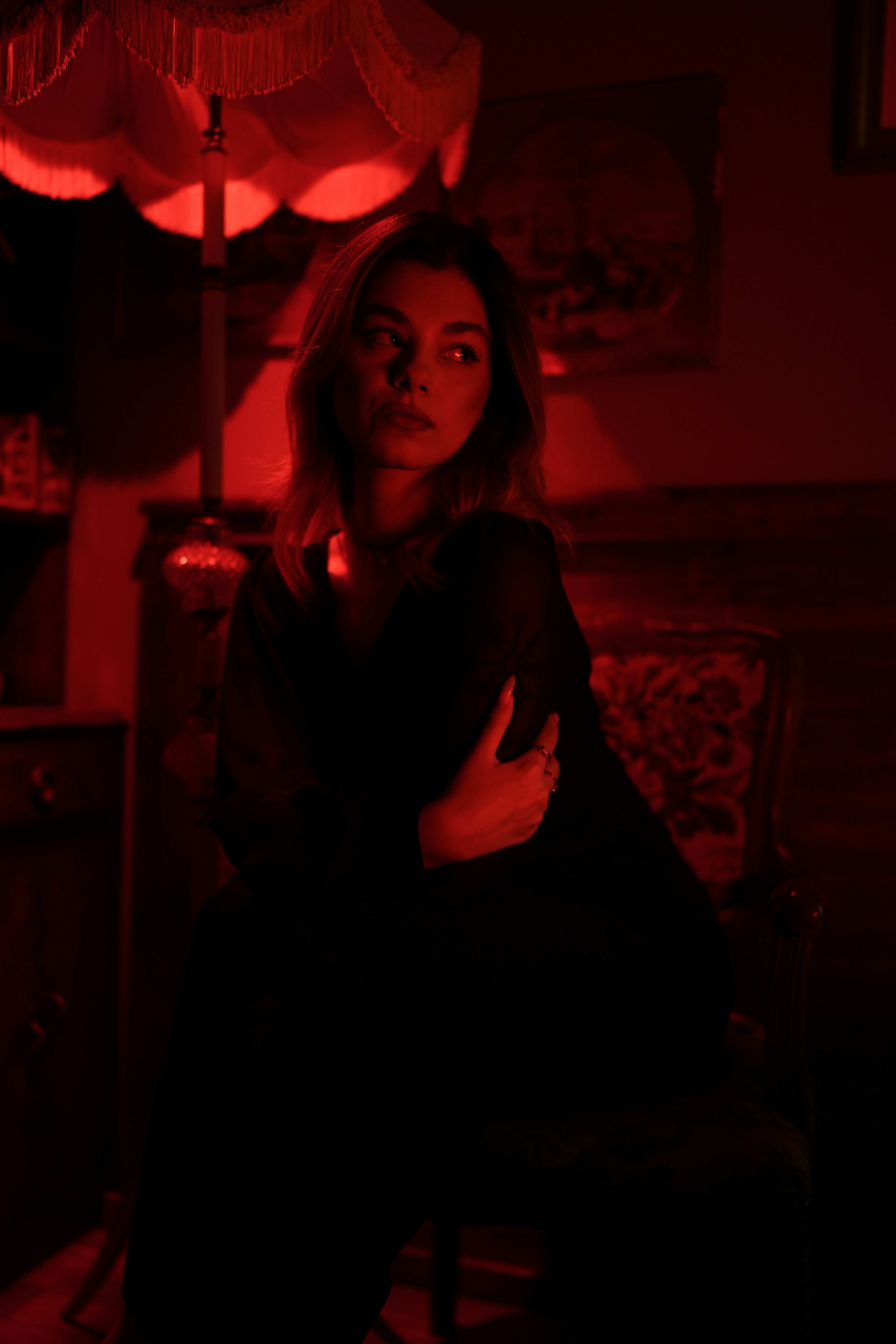 Red Velvet Quietude: A Figure in Dim Neon Bloom